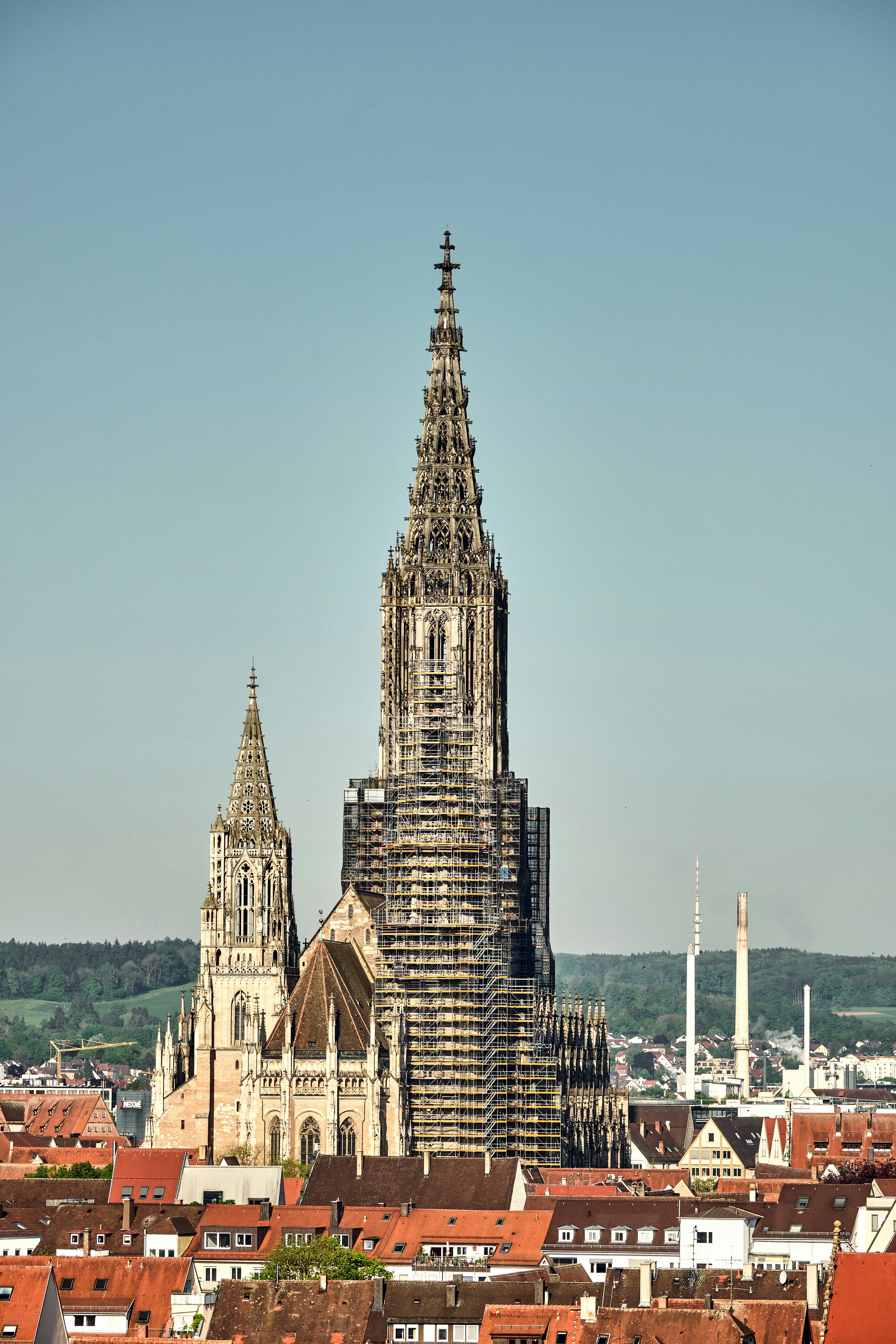 A large cathedral towering over a city filled with tall buildings photo ...