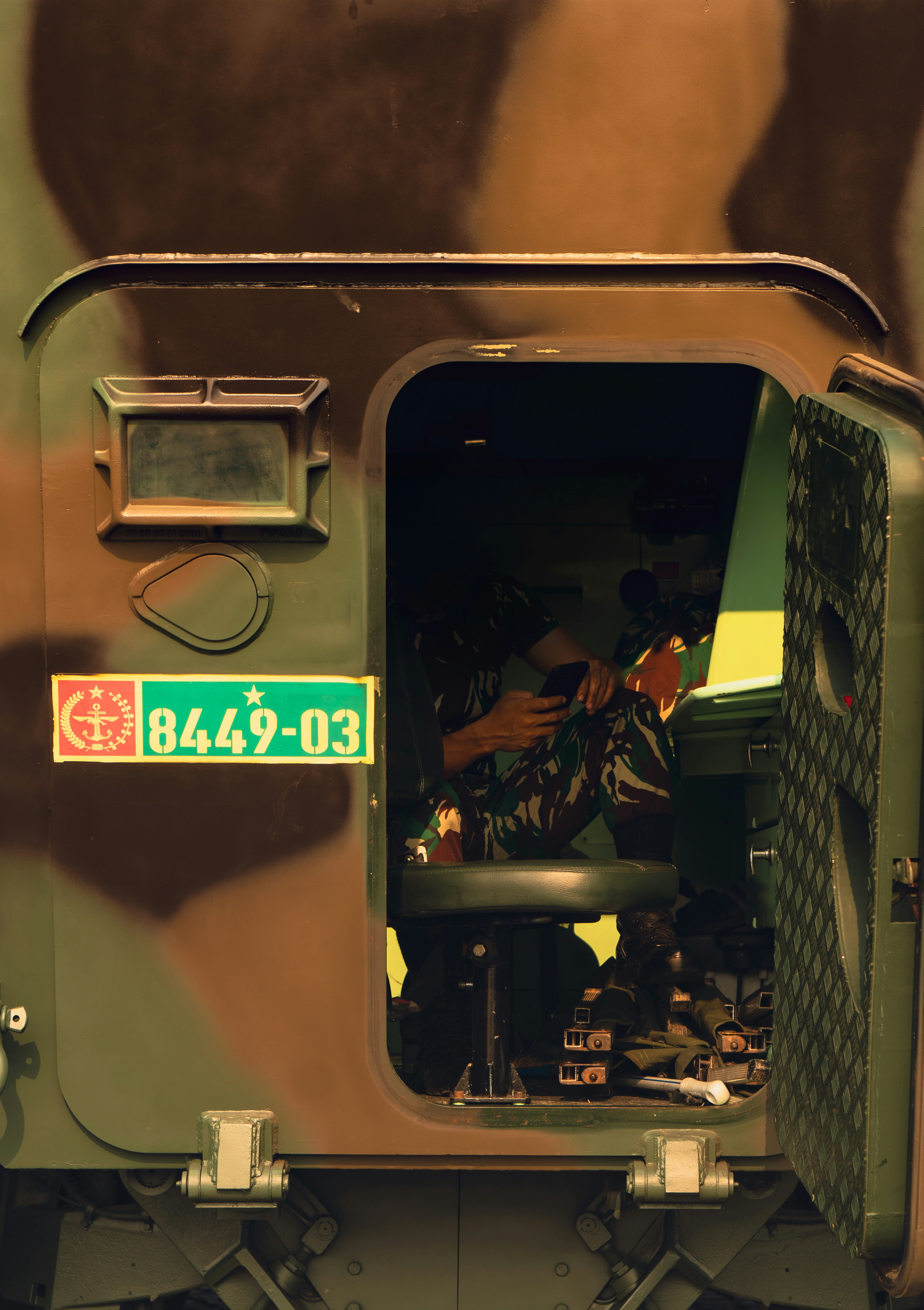 An army man slacking inside his APC.