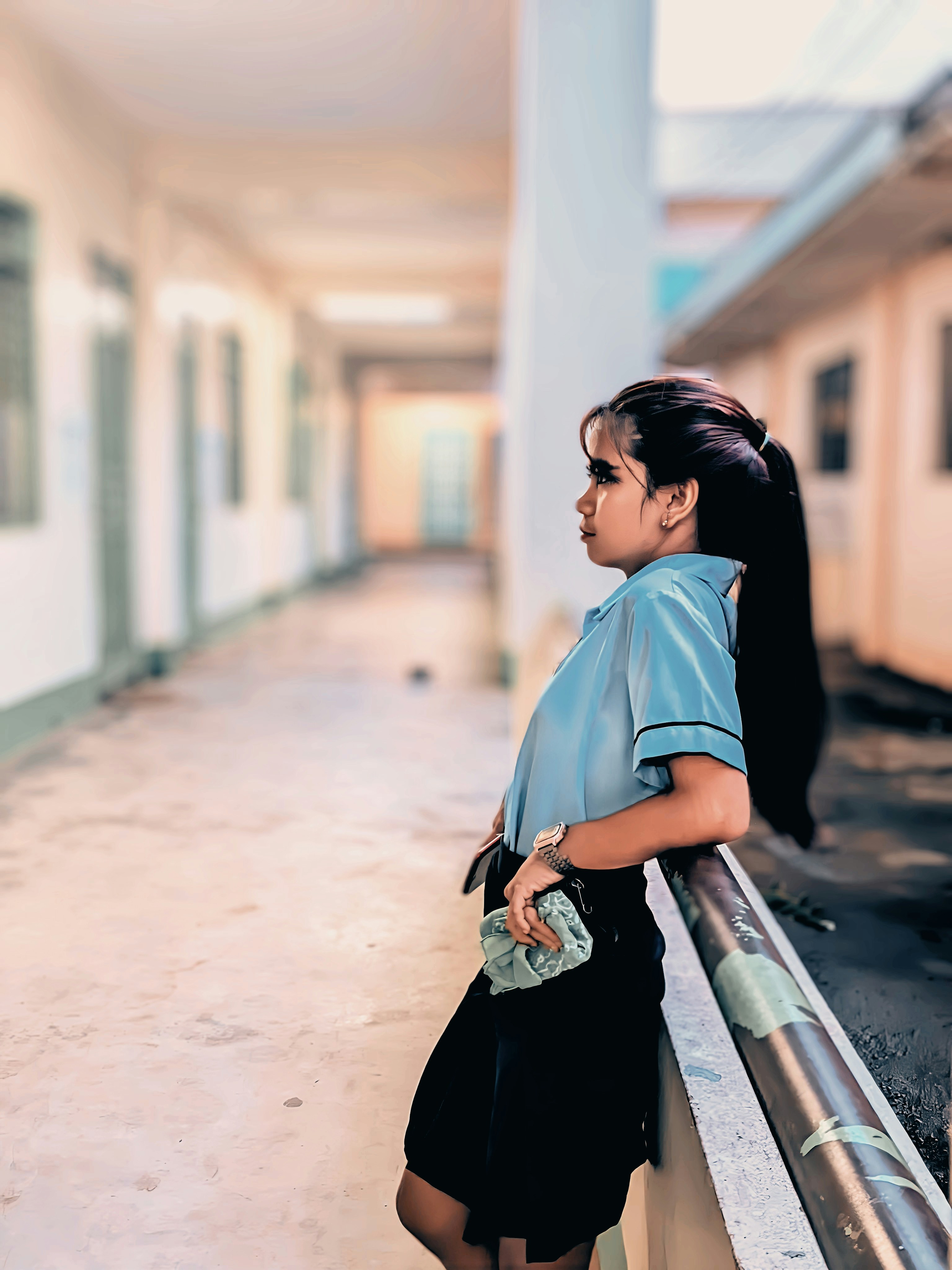 A woman leaning on a rail in a hallway photo – Free Cararayan Image on ...