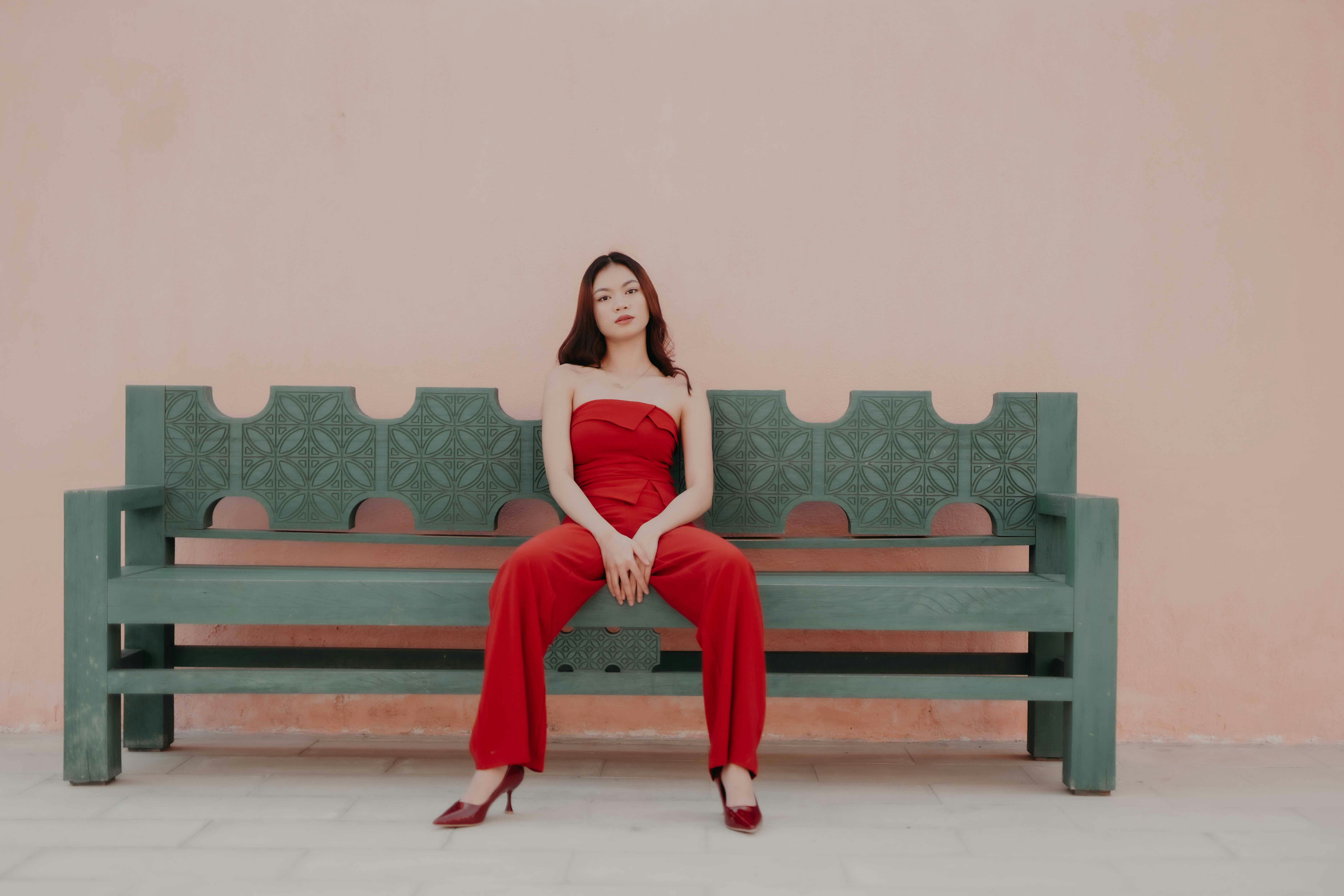 Crimson Draped Portrait on a Teal Bench by a Peach Wall