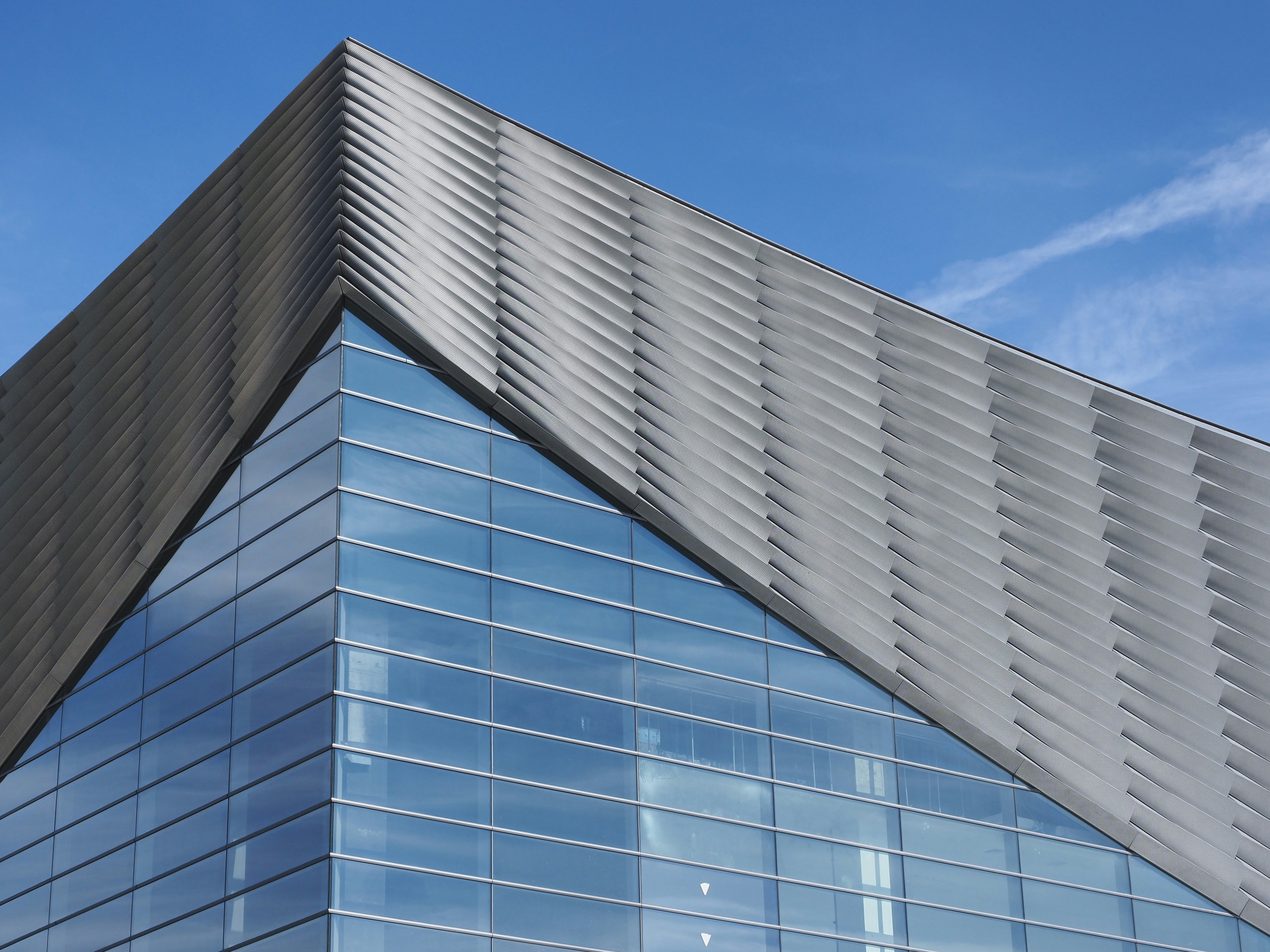 A tall building with a triangular roof on top of it photo – Free ...