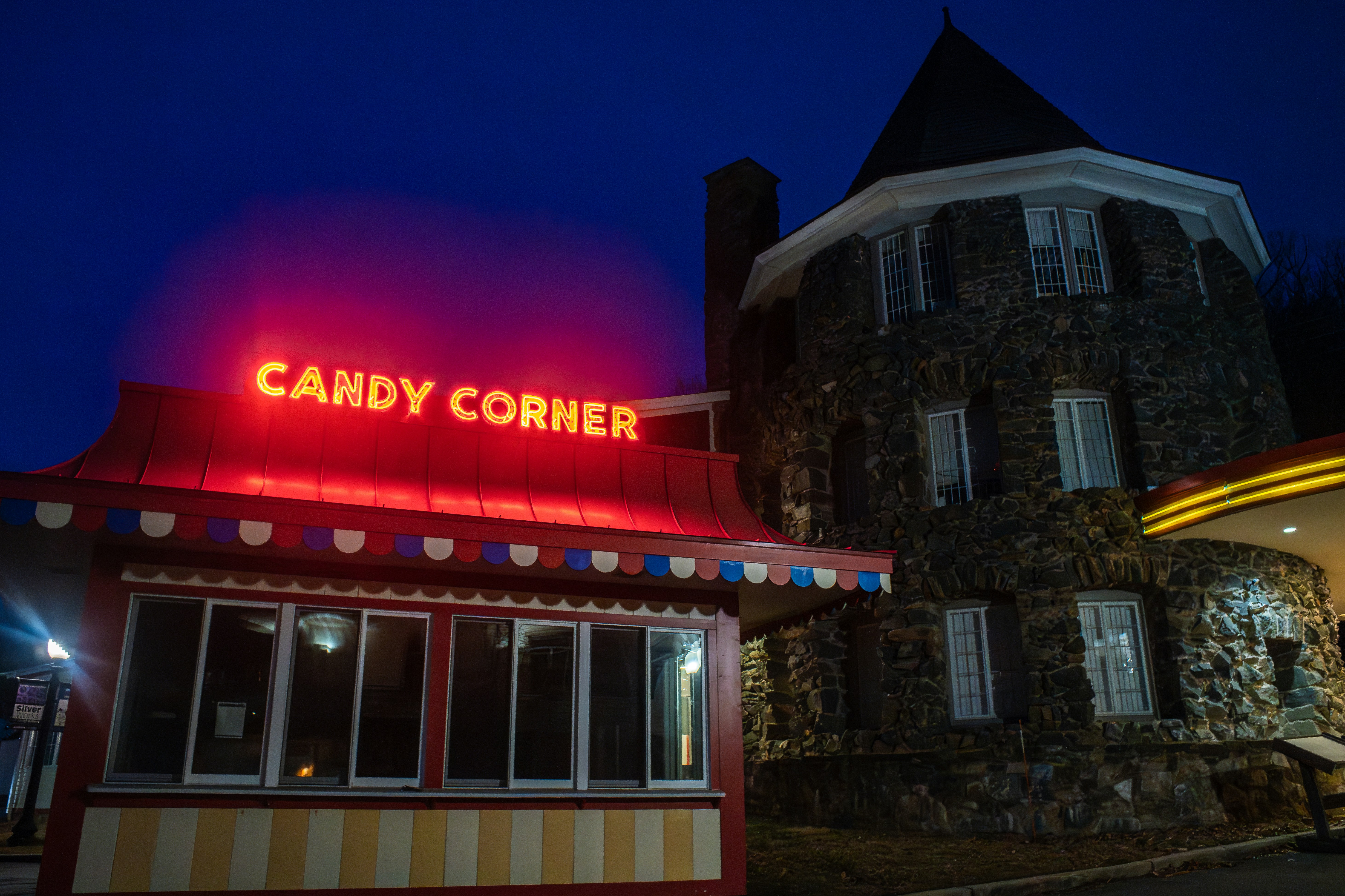A building with a candy corner lit up at night photo – Free Night Image ...