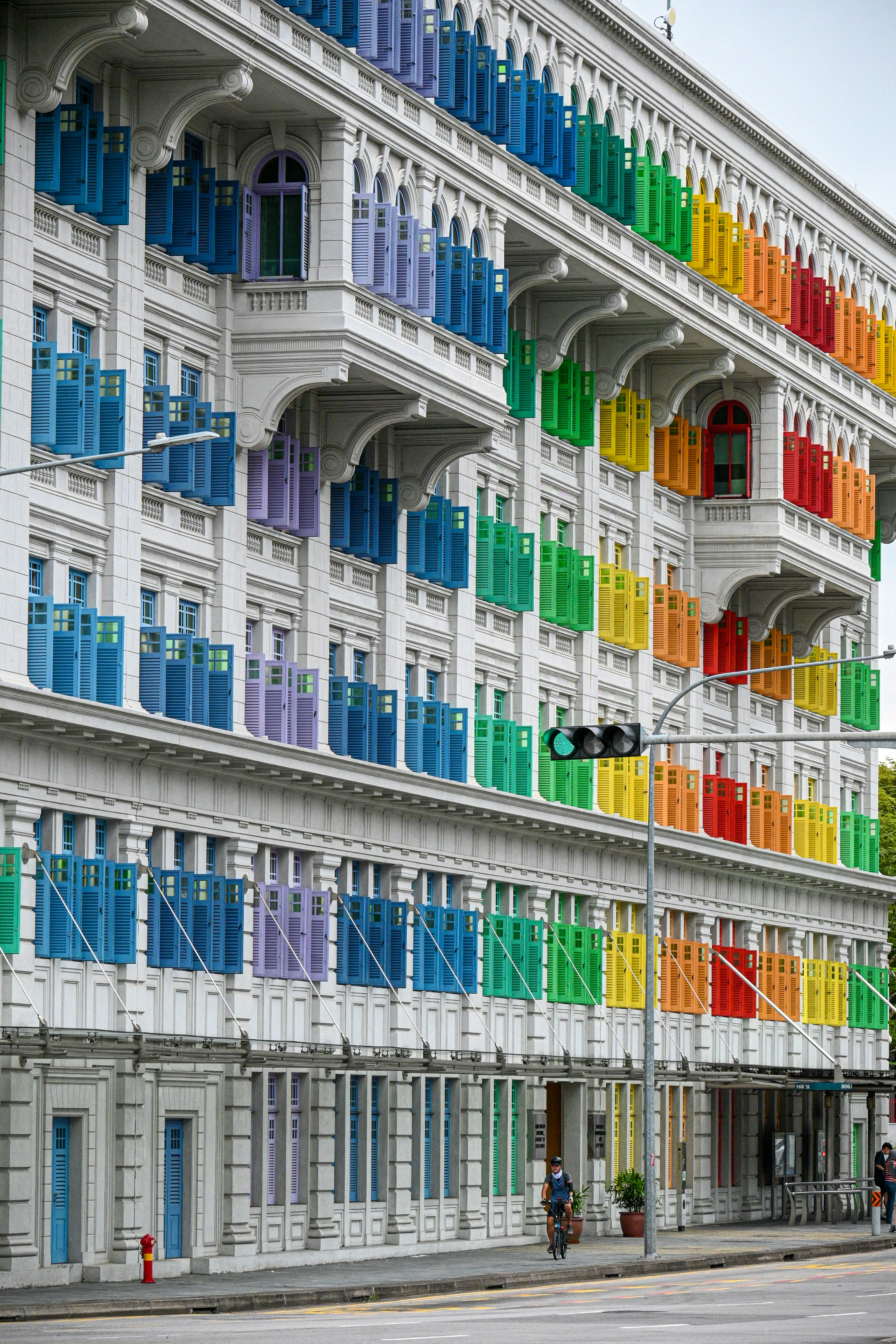 Rainbow Shutters along a Neoclassical Facade