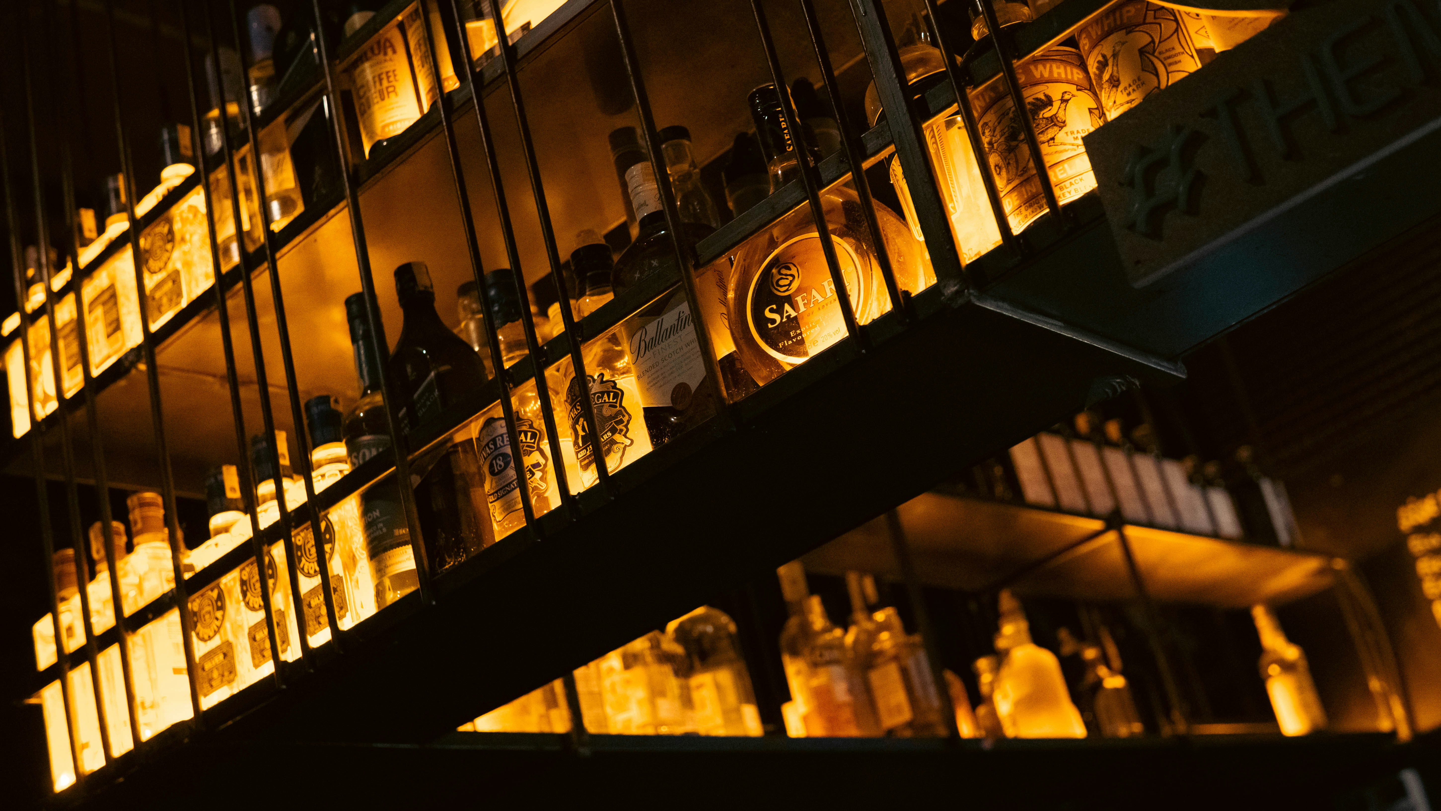 A tall building with lots of windows lit up at night photo – Free Bar ...