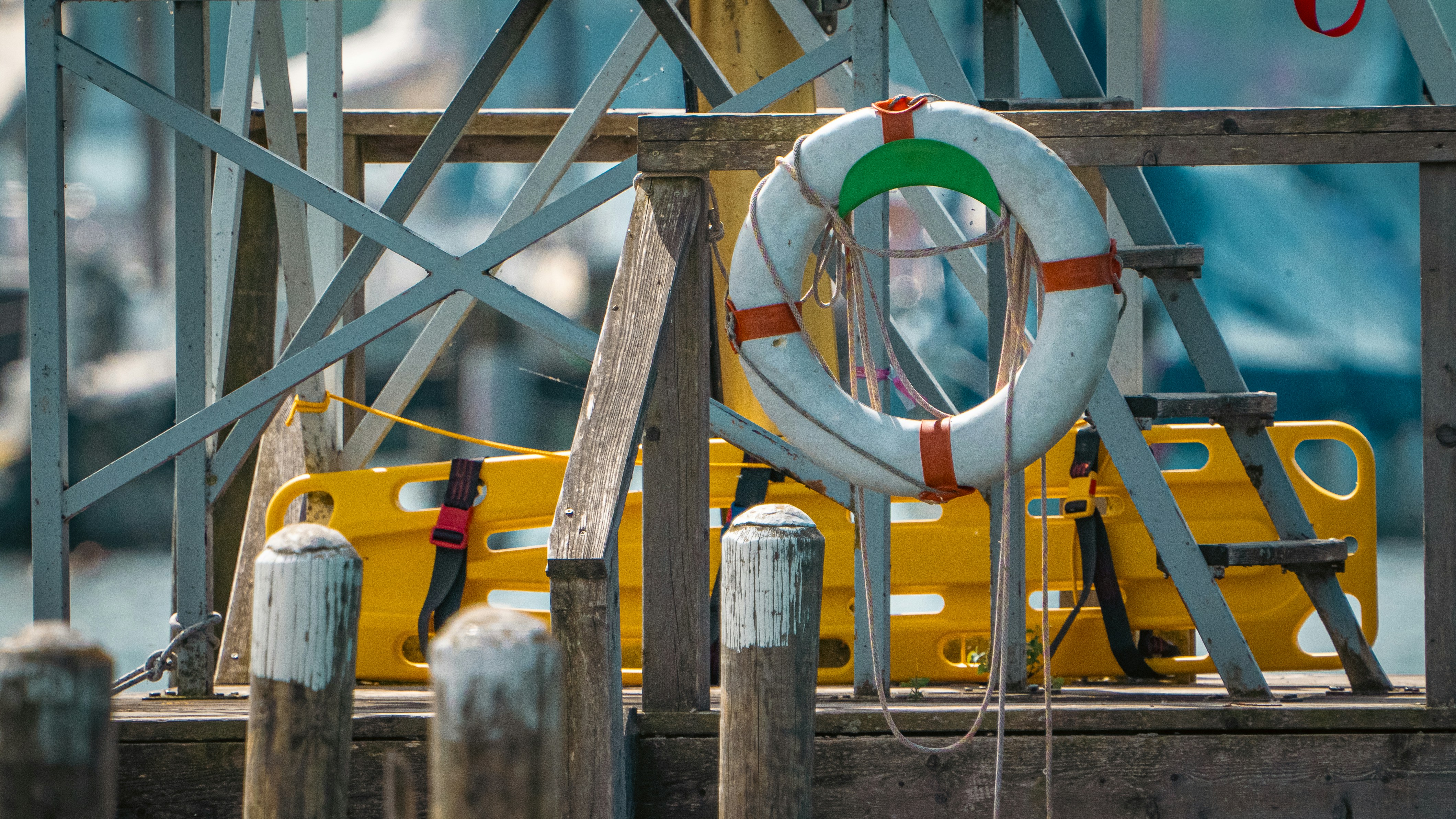 A life preserver sitting on a dock next to a life preserver photo ...