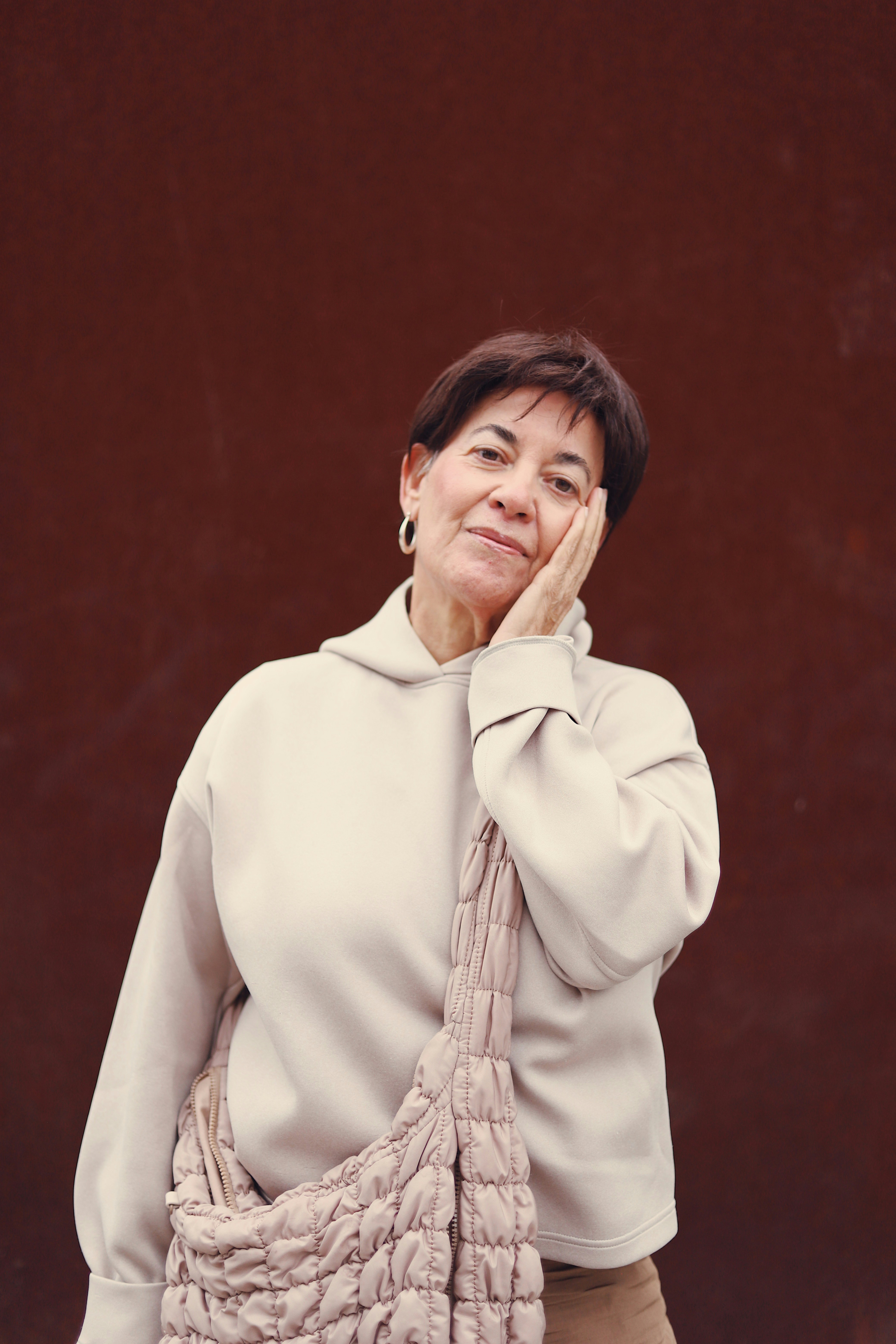 A woman is holding a purse and talking on the phone photo – Free ...