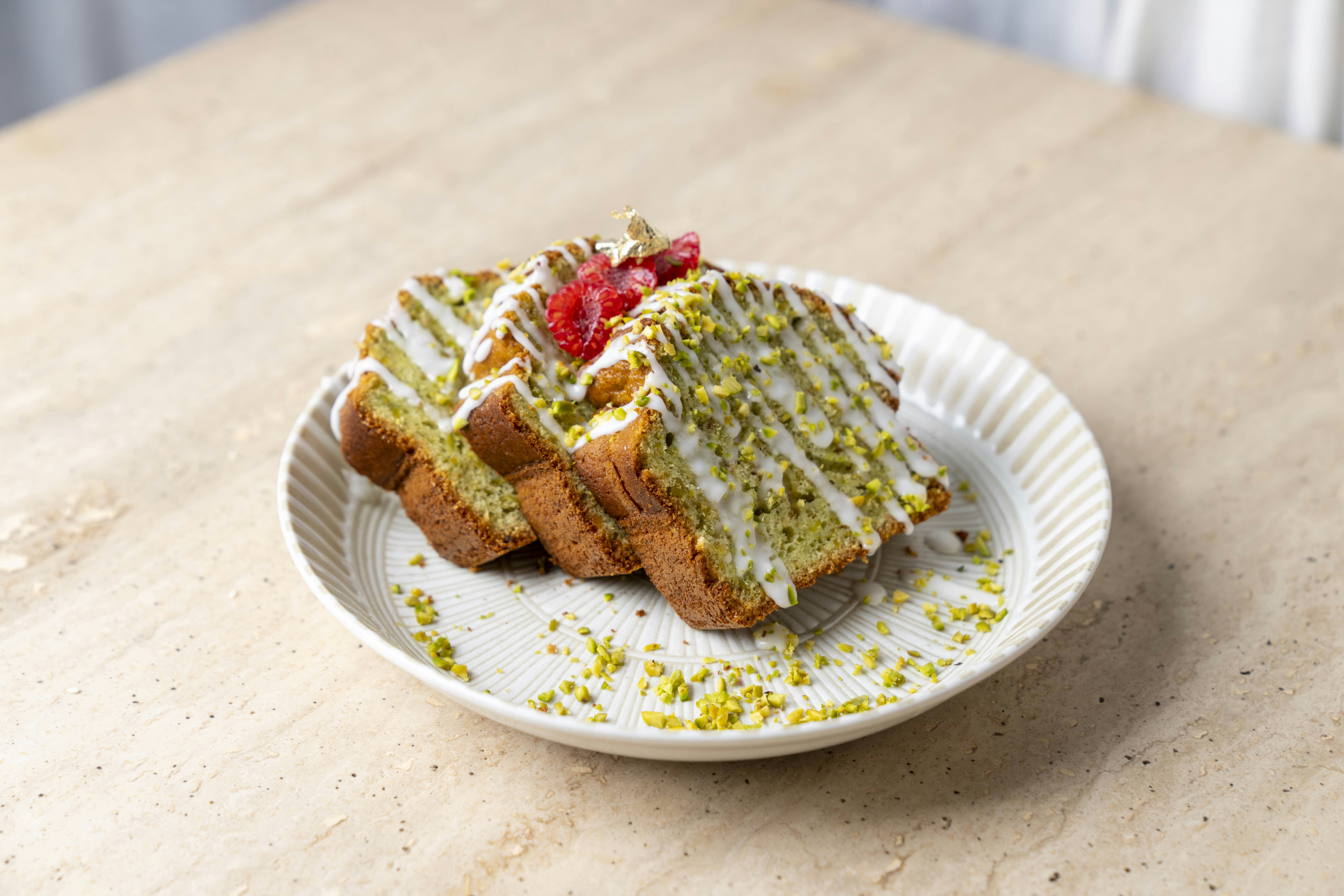 Forest Green Pistachio Drizzle Cake on a Frilled Plate