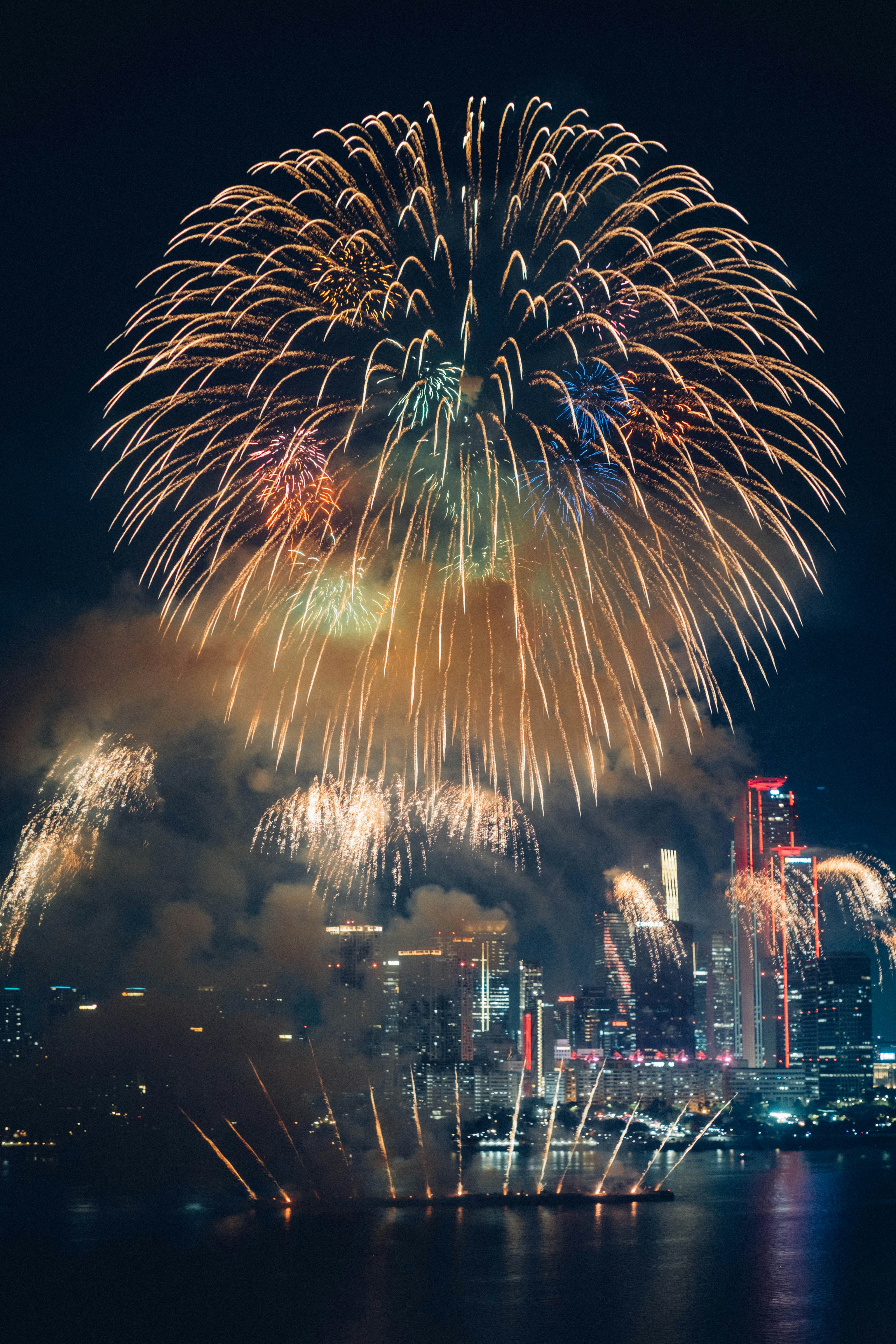 A large fireworks display over a city at night photo – Free Fireworks ...