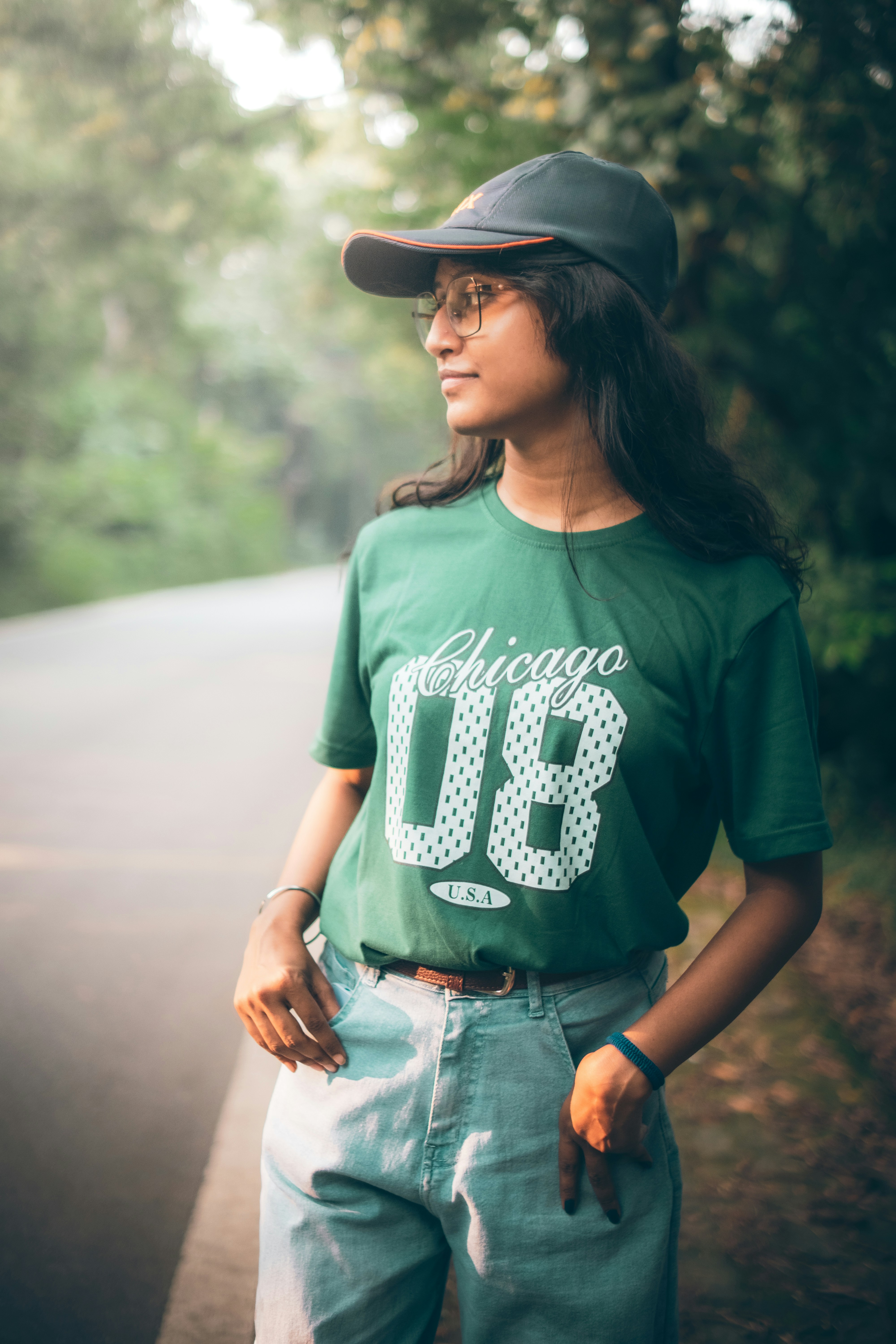 Morning light frames a green Chicago 08 tee on a quiet tree-lined road