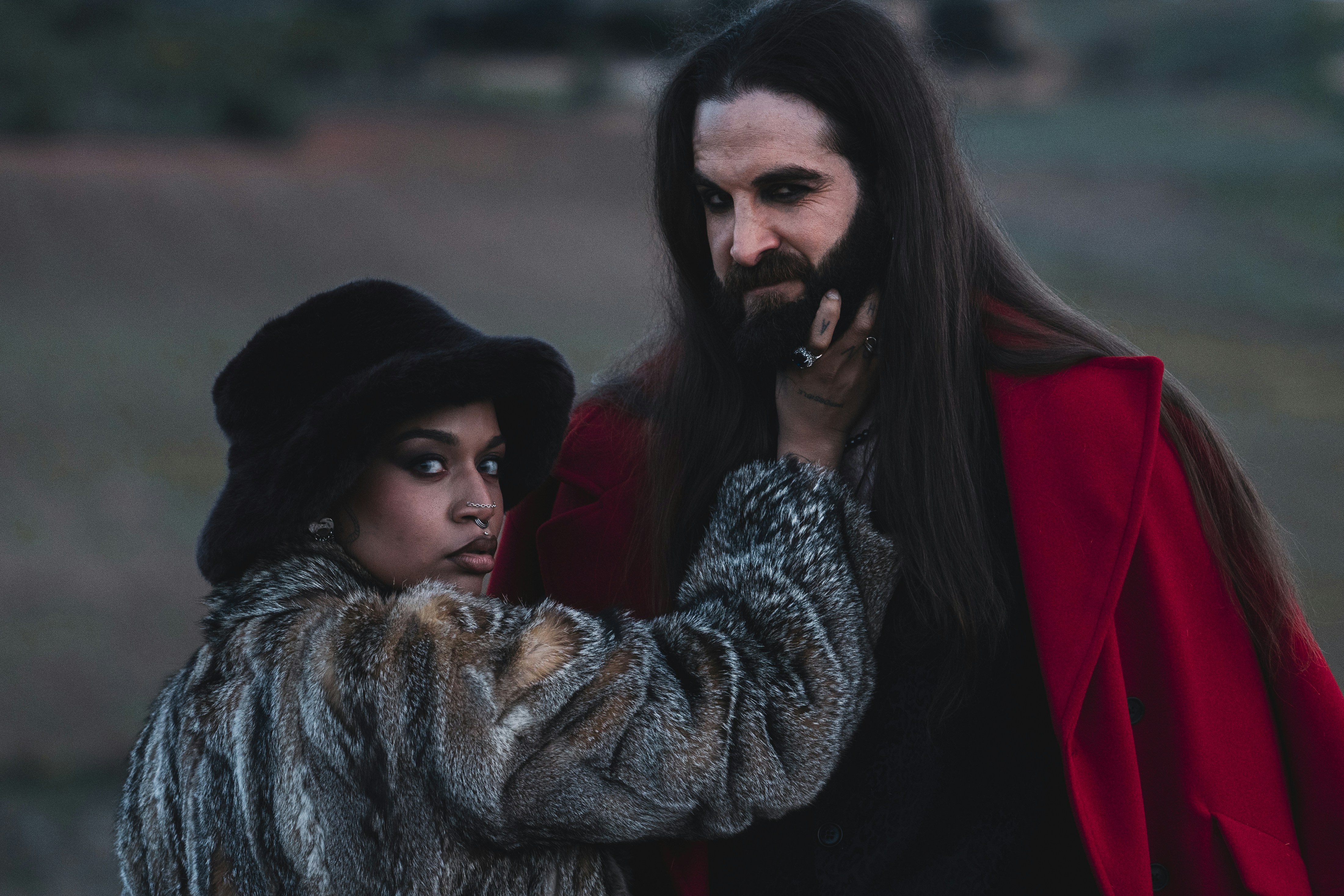 Crimson Cloak, Furred Embrace: A Moody Outdoor Portrait