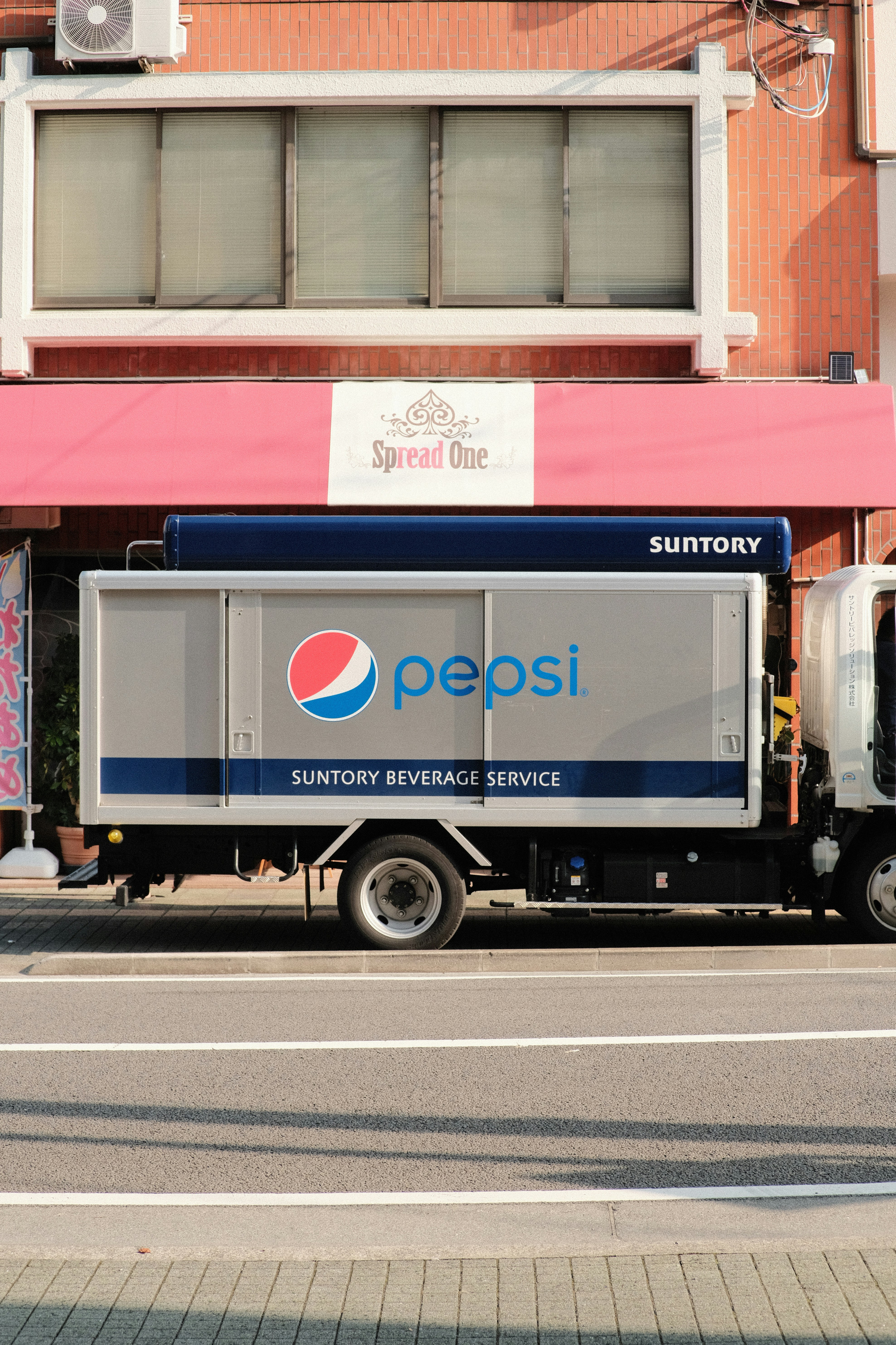 A pepsi delivery truck parked in front of a building photo – Free ...