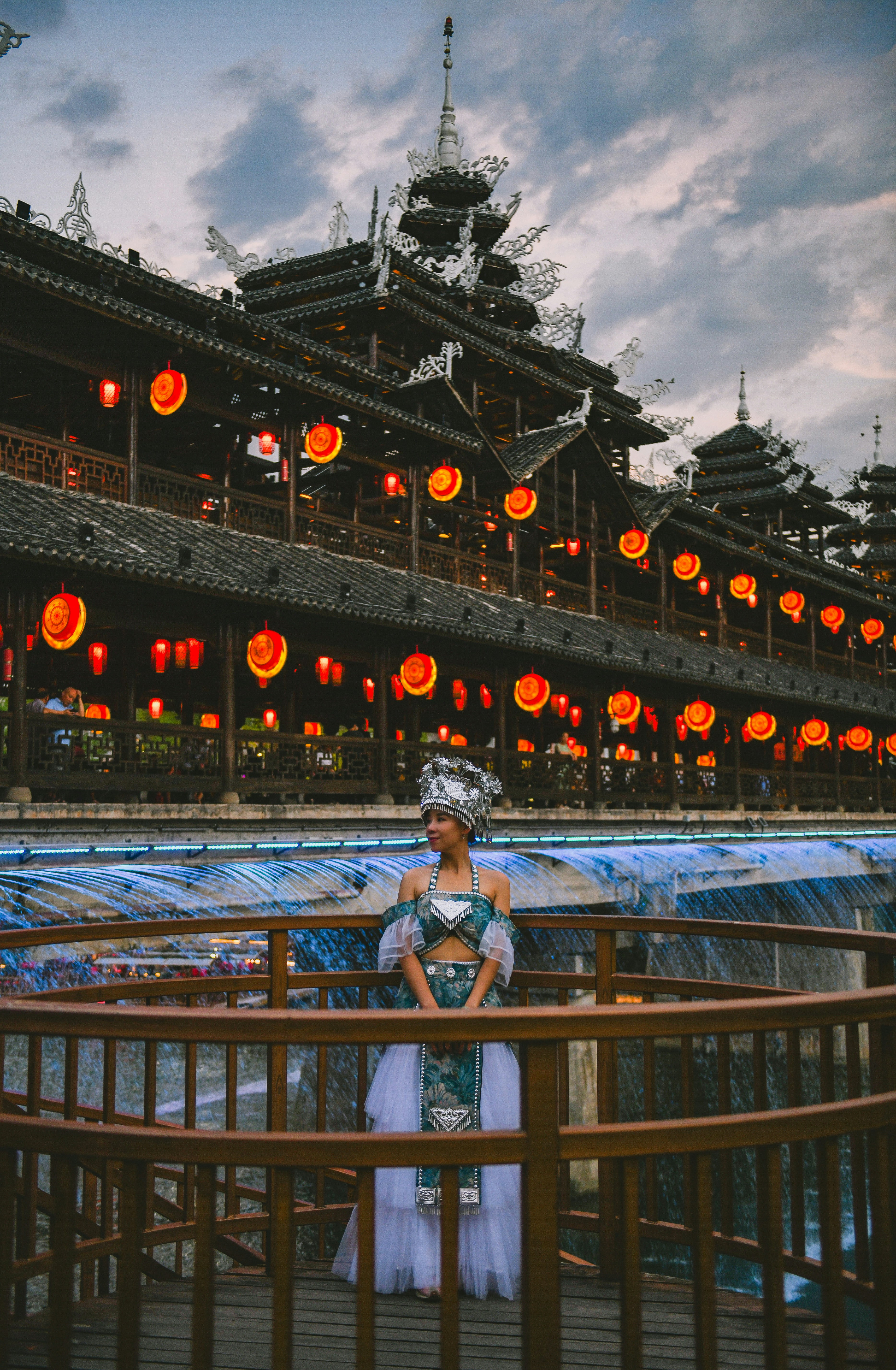 Silk and Lanterns Along the River: A ceremonial dancer framed by lantern-lit eaves