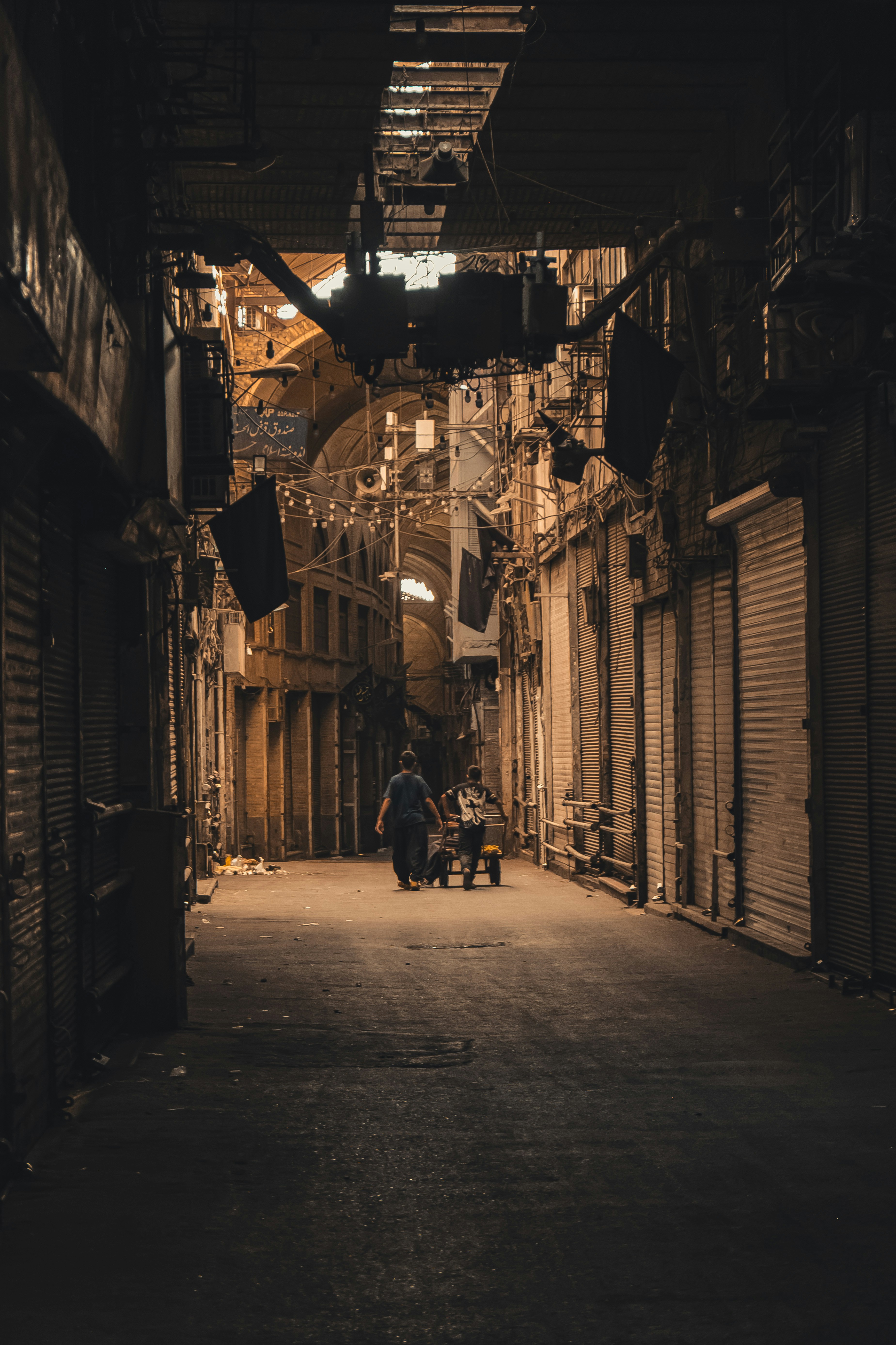 A dark alley way with people walking down it photo – Free Wallpaper 4k ...