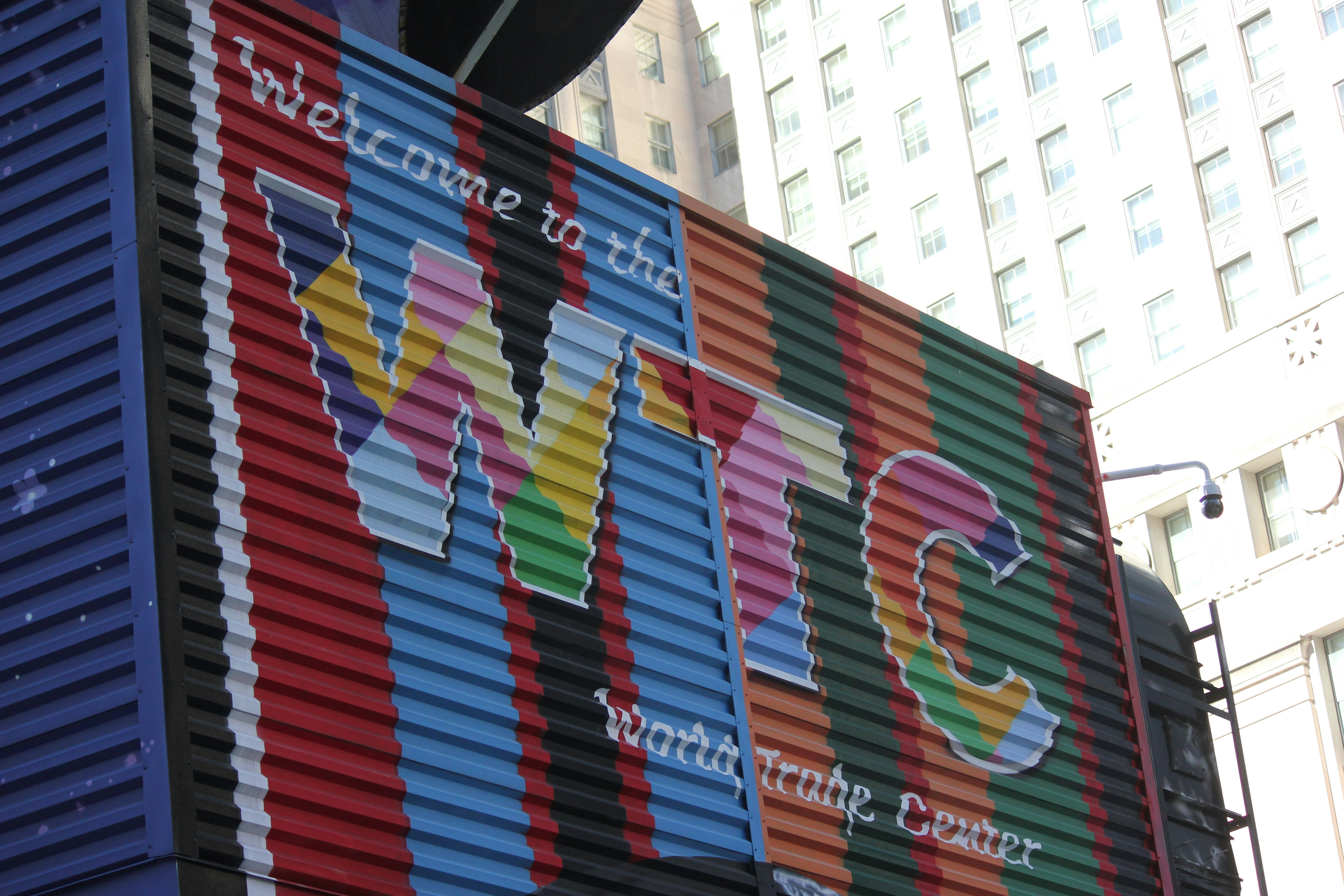 Multicolored WTC sign sprawls across a corrugated facade, announcing Welcome to the WTC in bold, overlapping letters.