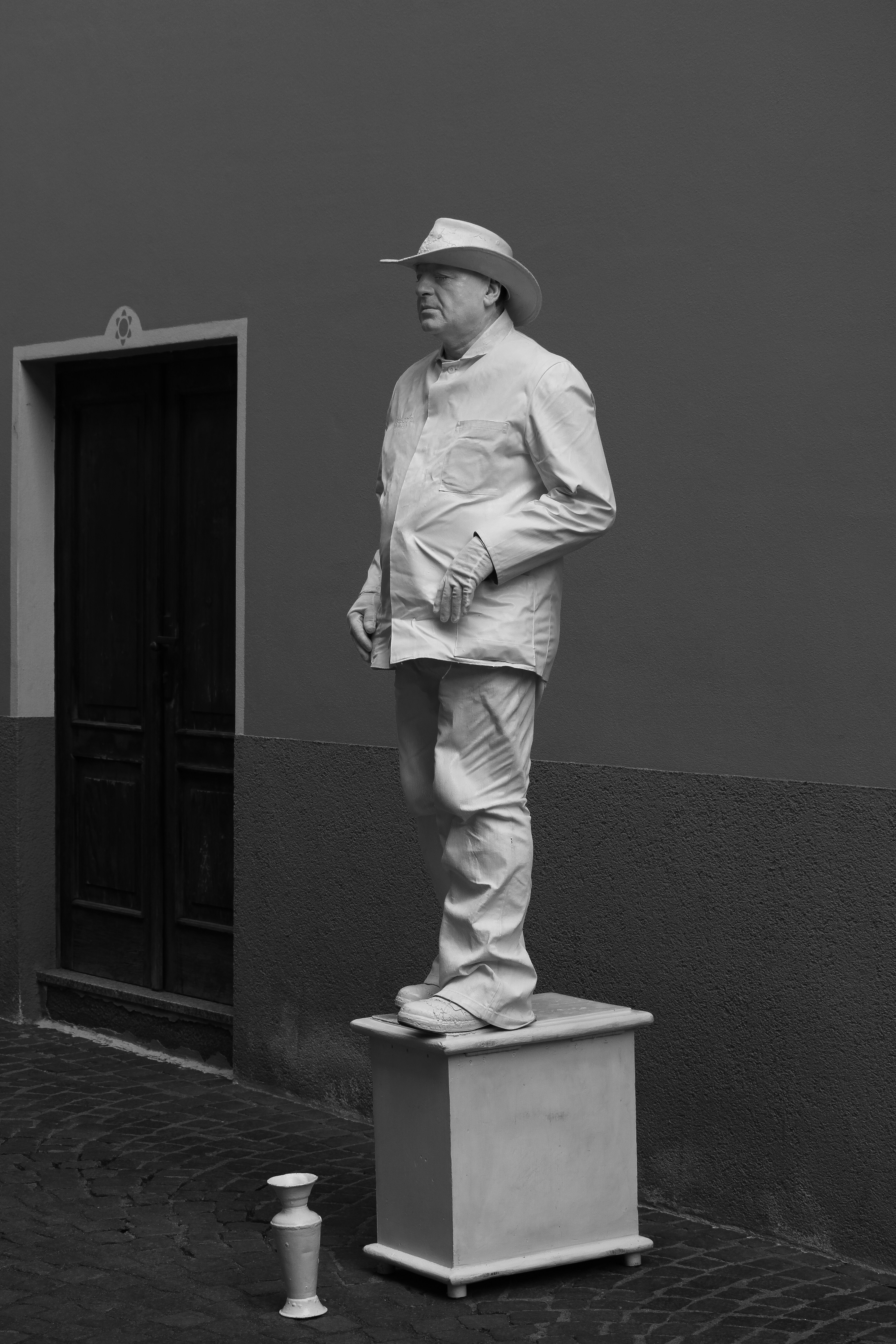 Watchman on the Cobblestone: A Quiet Statue by the Doorway