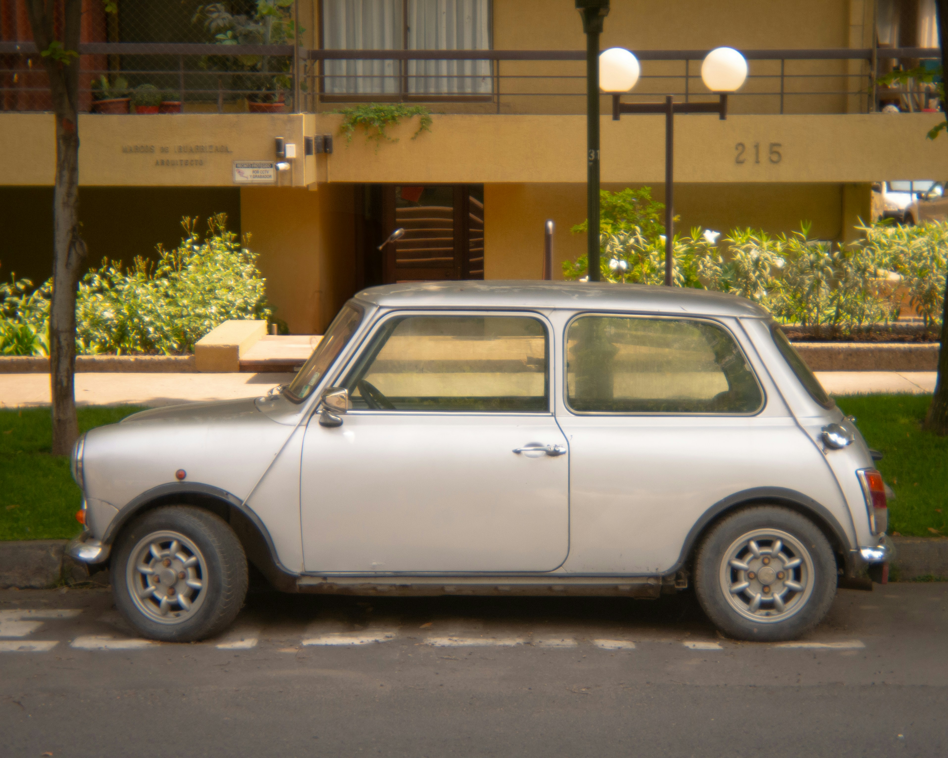 A small white car parked on the side of the road photo – Free Santiago ...