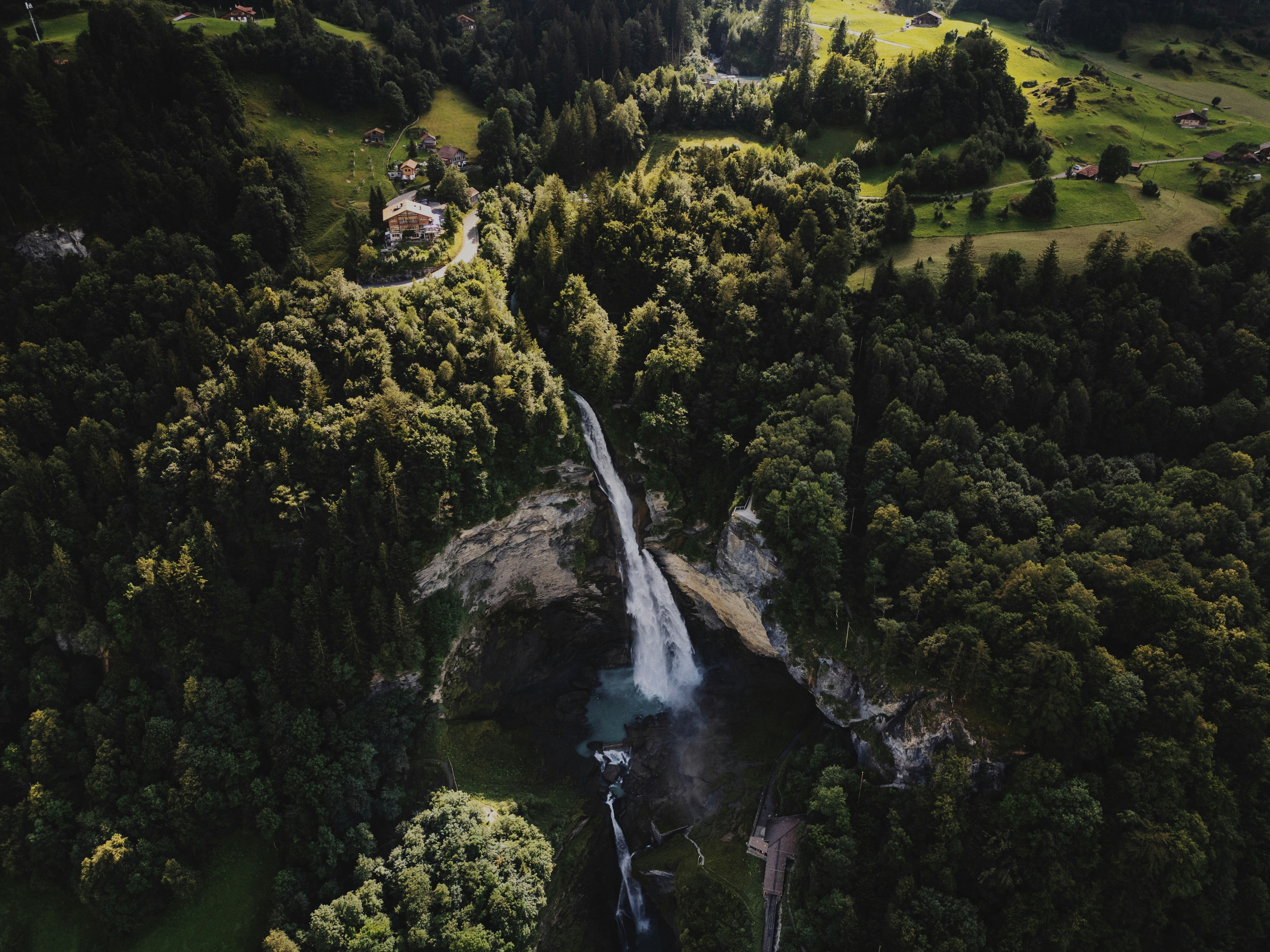 An aerial view of a waterfall surrounded by trees photo – Free Forest ...