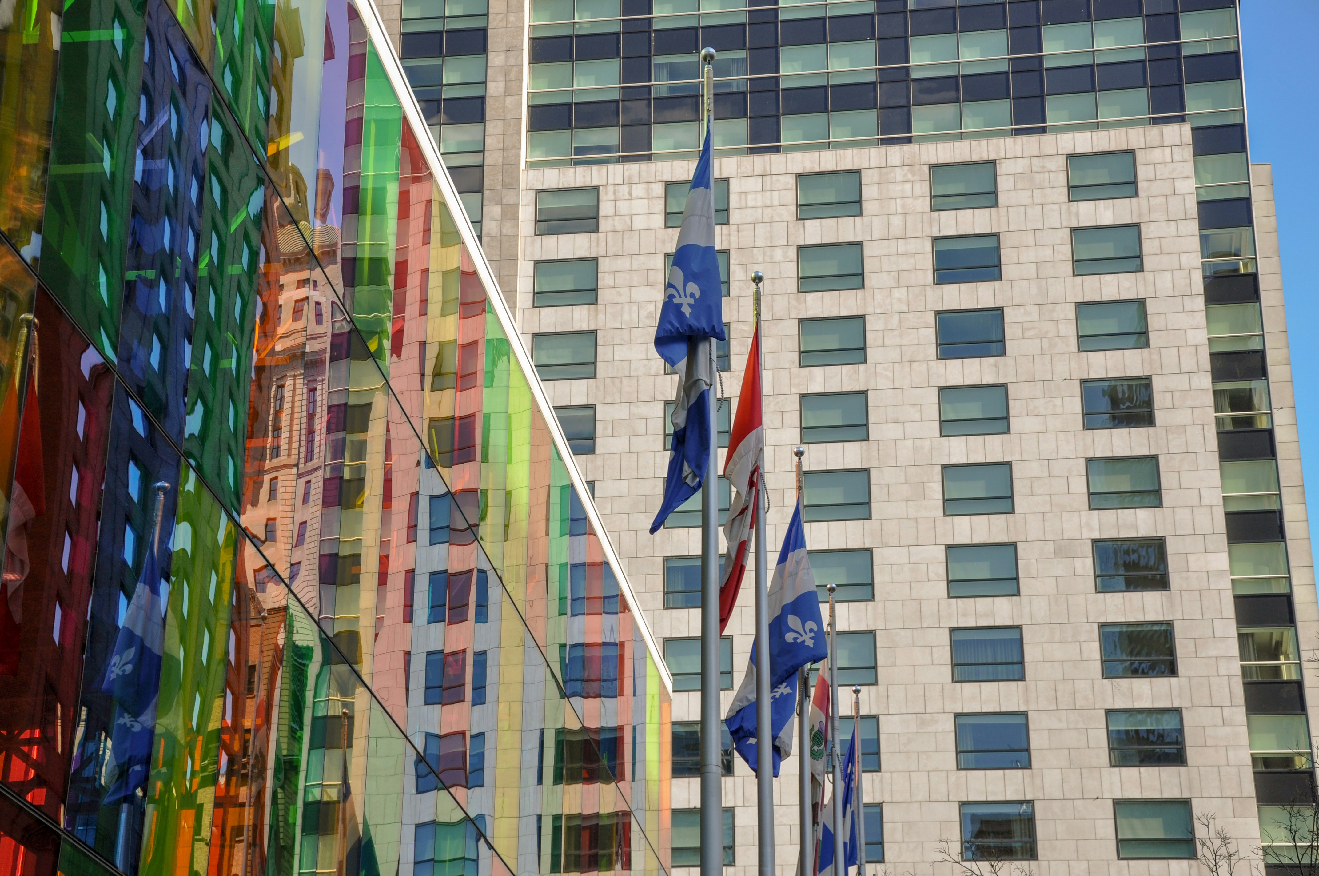 Prismatic Curtain Meets Flagline: A Rainbow Facade Before the Corporate Tower