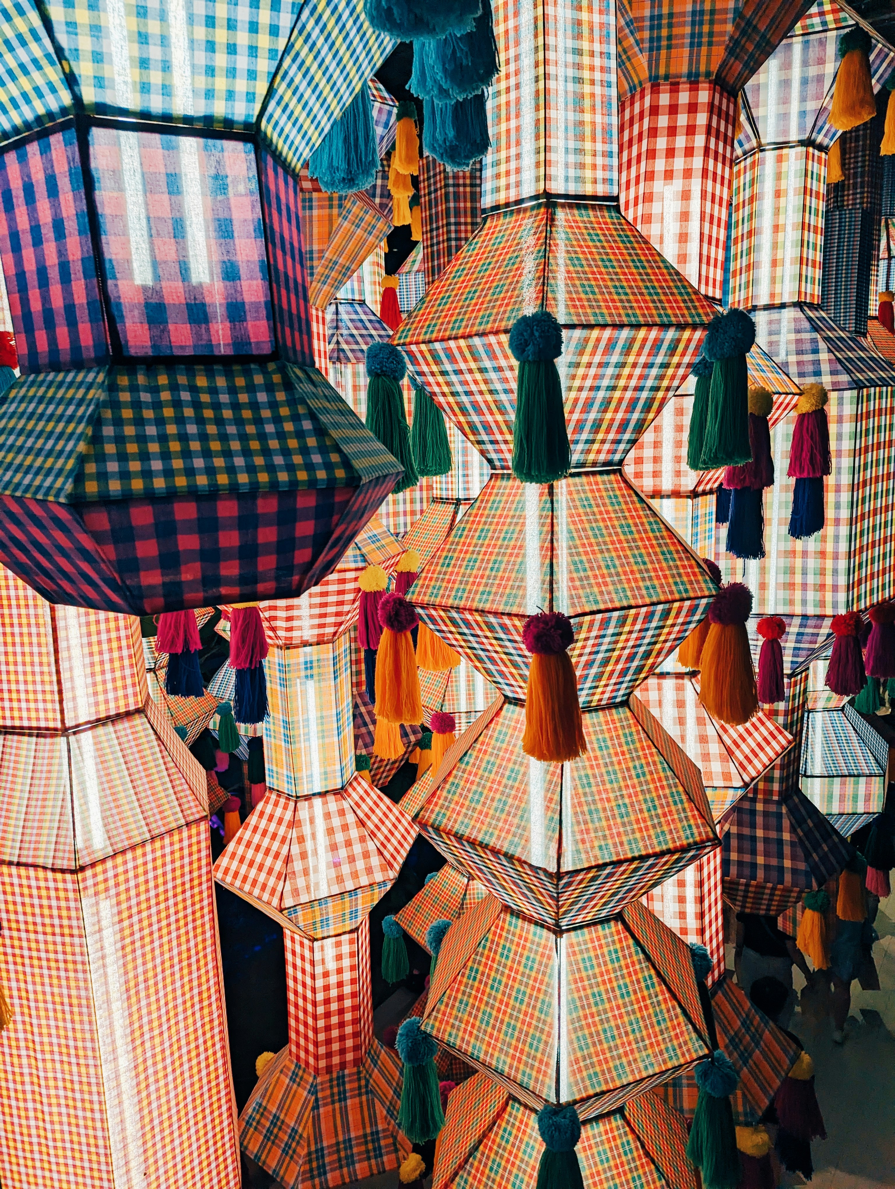 A group of colorful umbrellas hanging from the ceiling