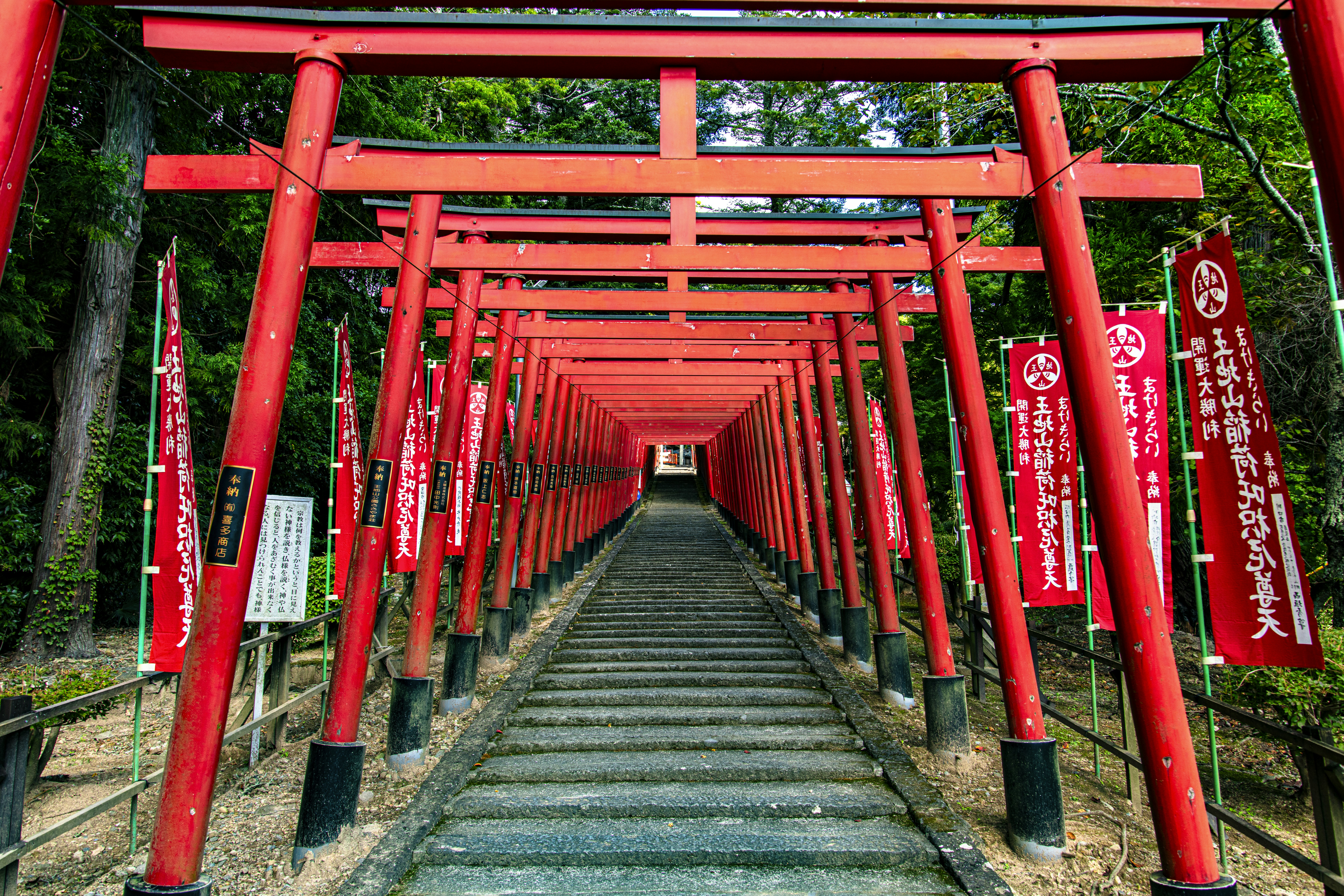A very long red bridge with lots of signs on it photo – Free Travel ...