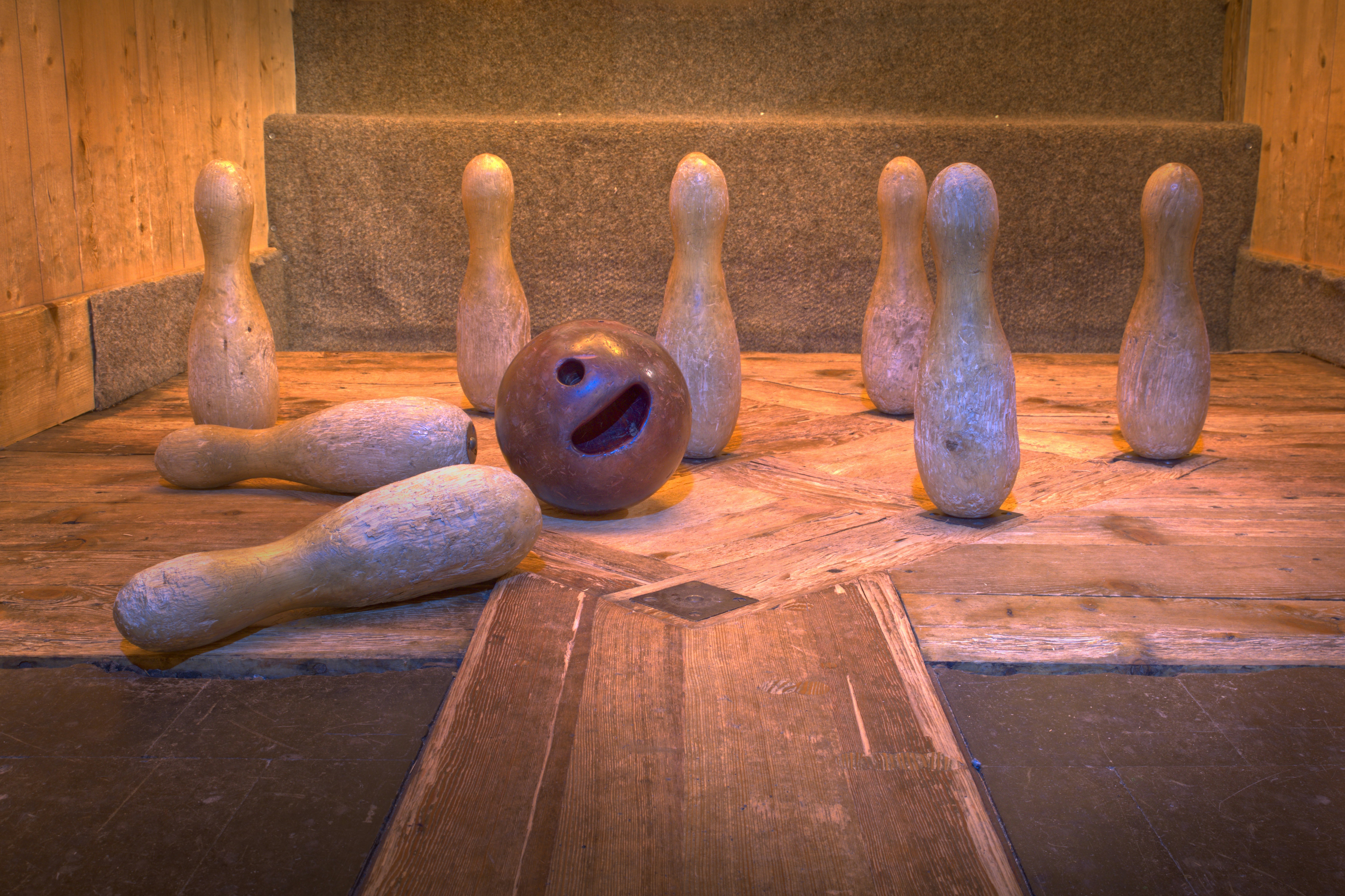 A group of fake bowling pins sitting on top of a wooden floor photo ...