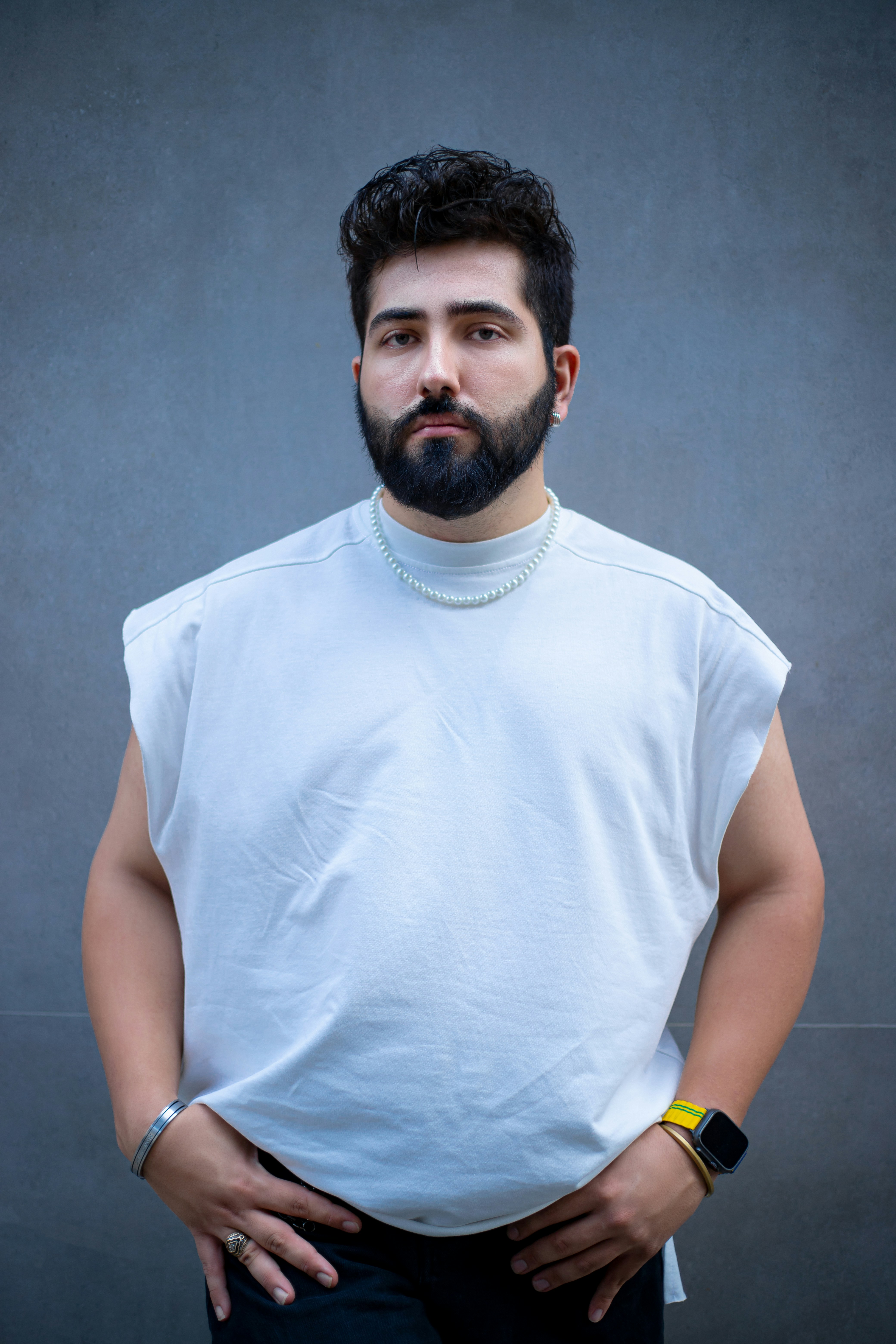 Beard, Pearl, and Presence: A Minimal Portrait in White Against Gray