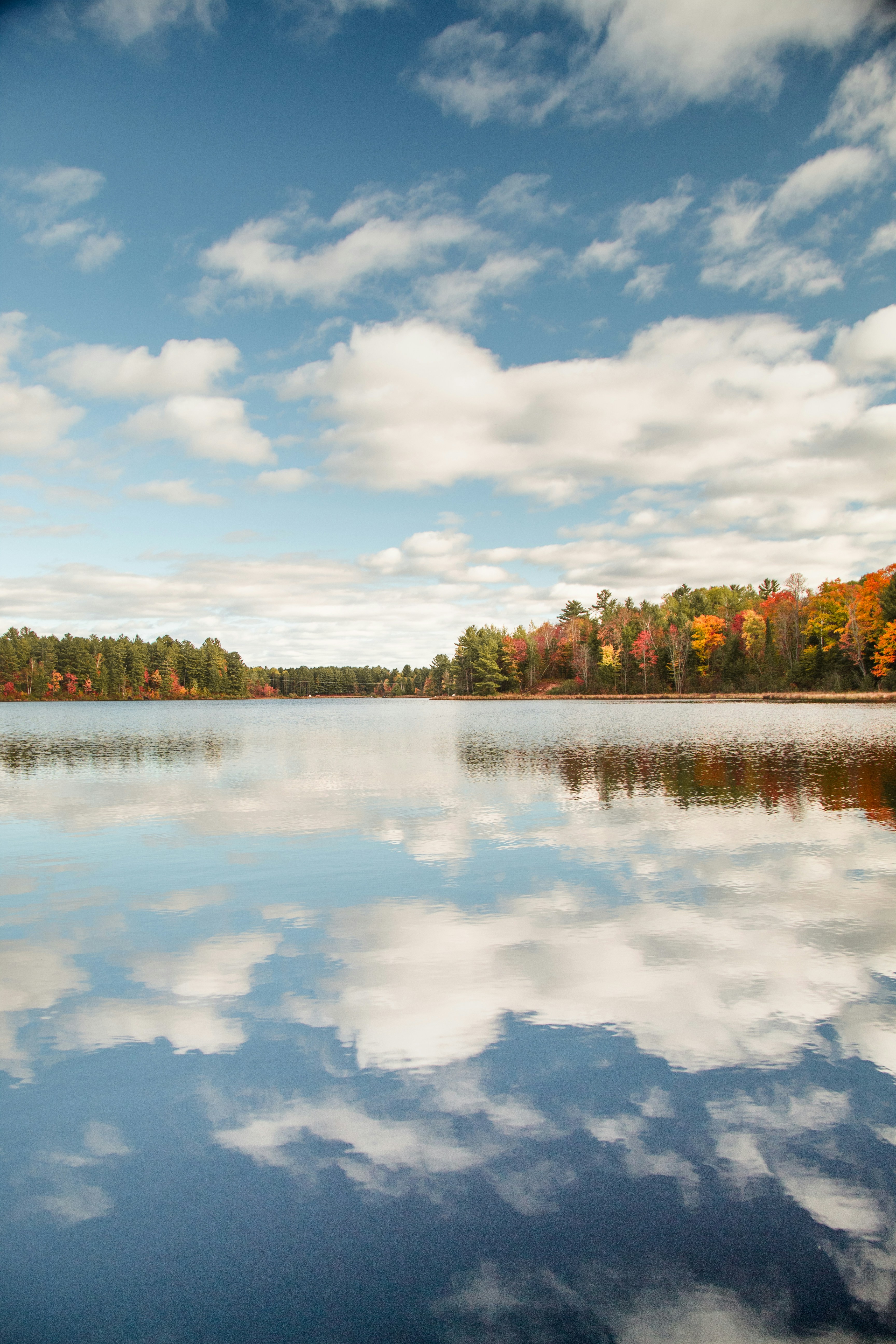 Autumn's Glassy Silence: Clouds Mirror the Lake