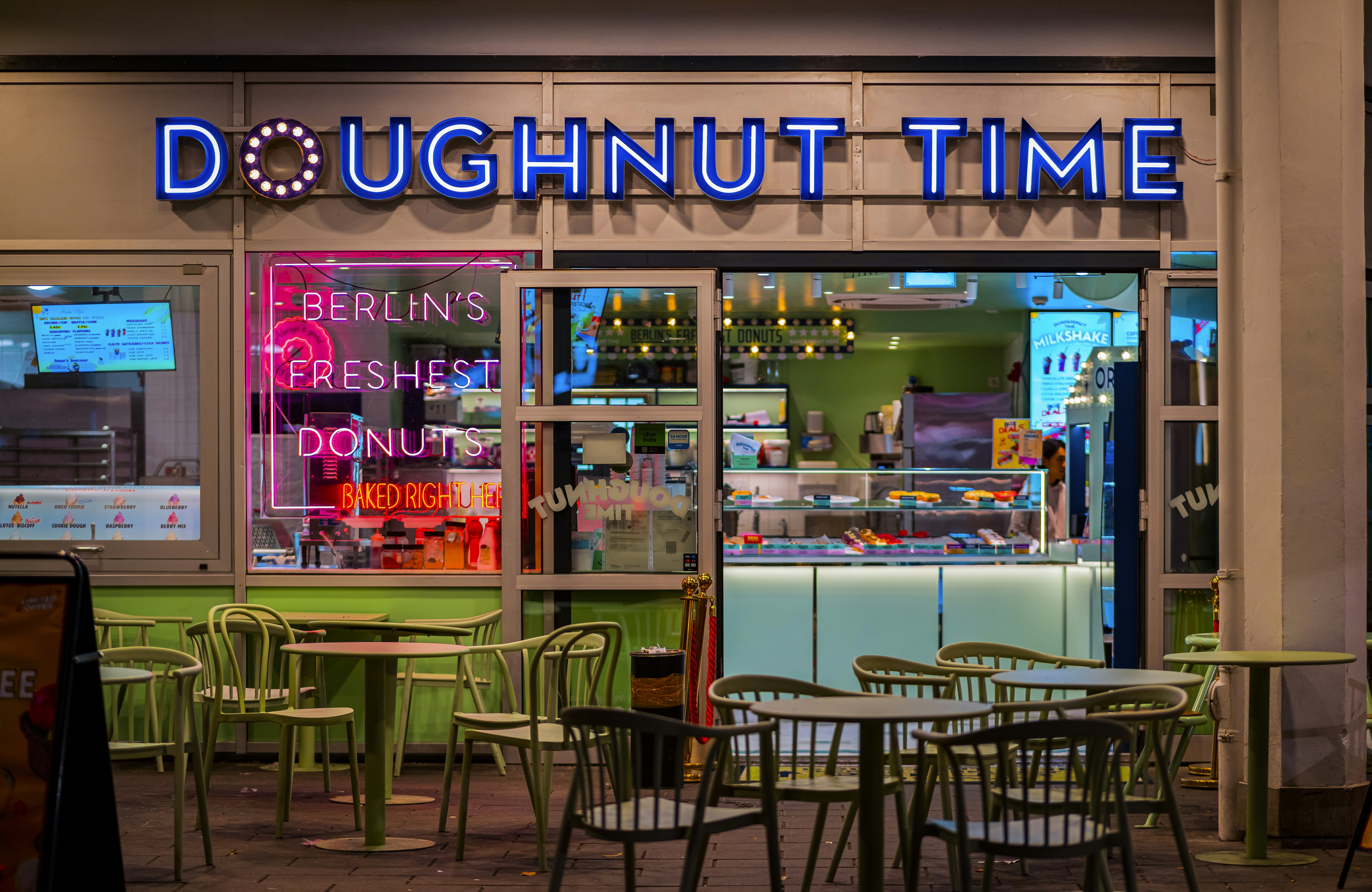 A doughnut time restaurant with tables and chairs outside photo – Free ...