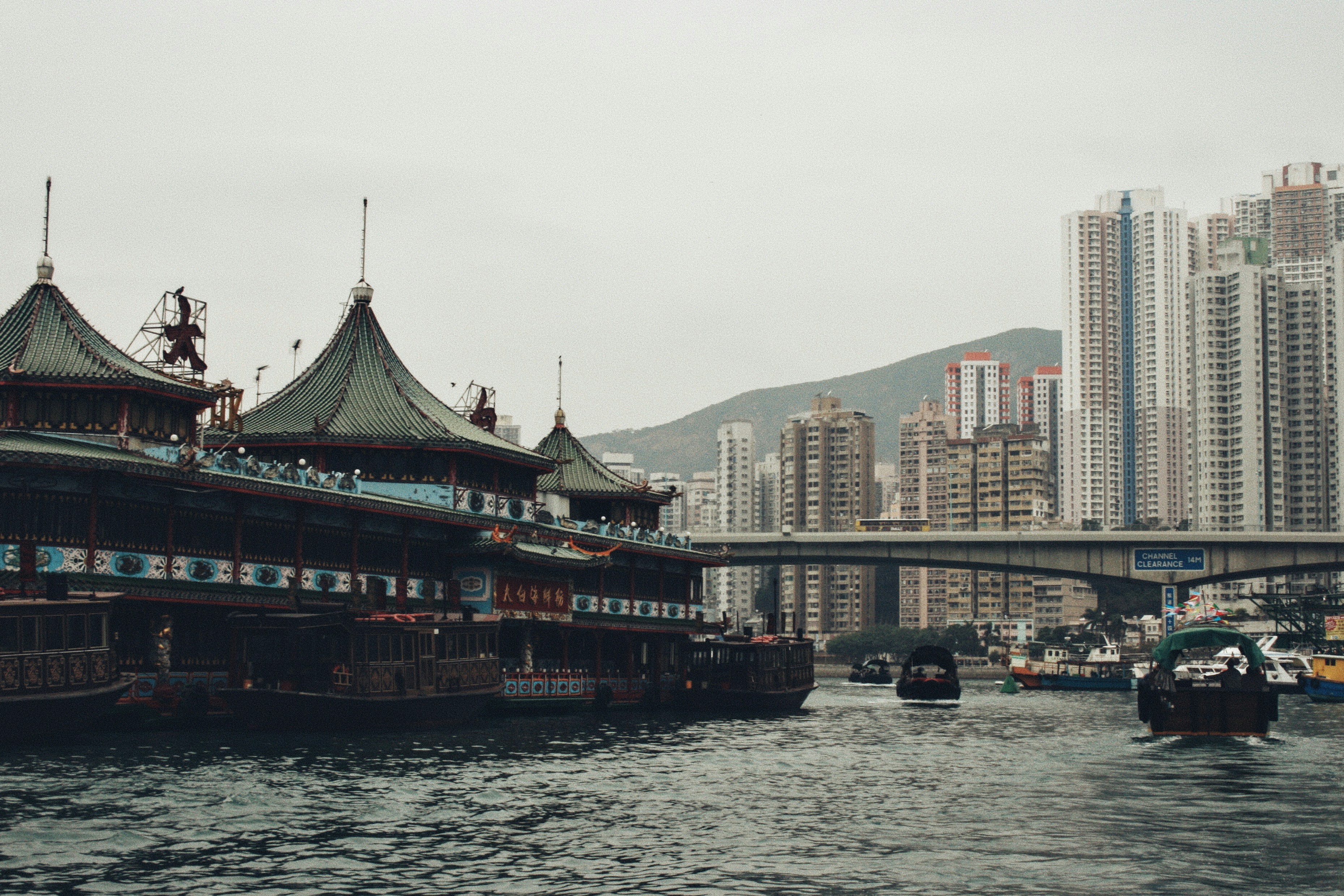 Dragon Boats by the Riverside: Pavilions Against a Rising Skyline