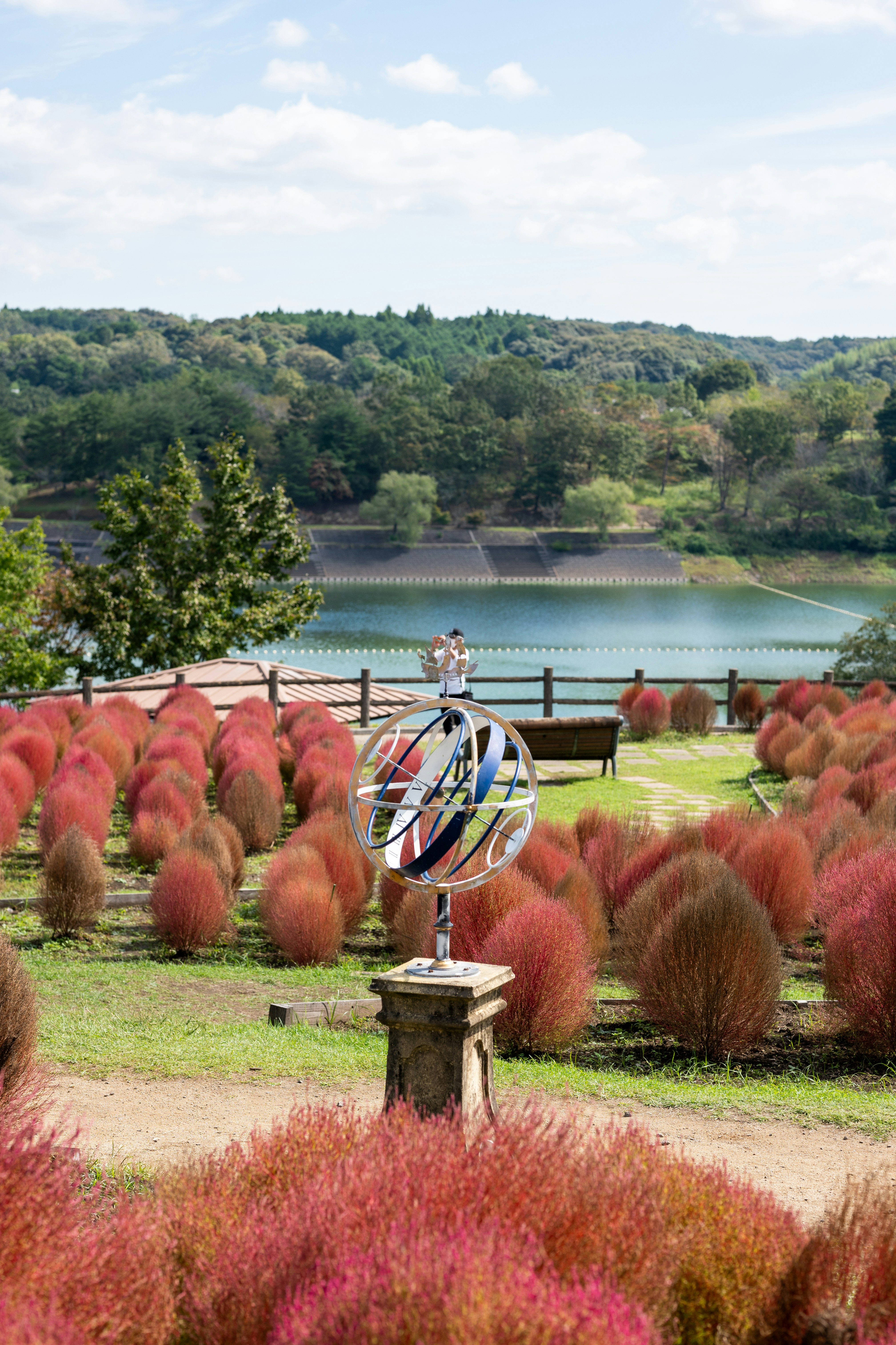 Orbital Sculpture Amid Rosy Tussocks by the Calm Lake