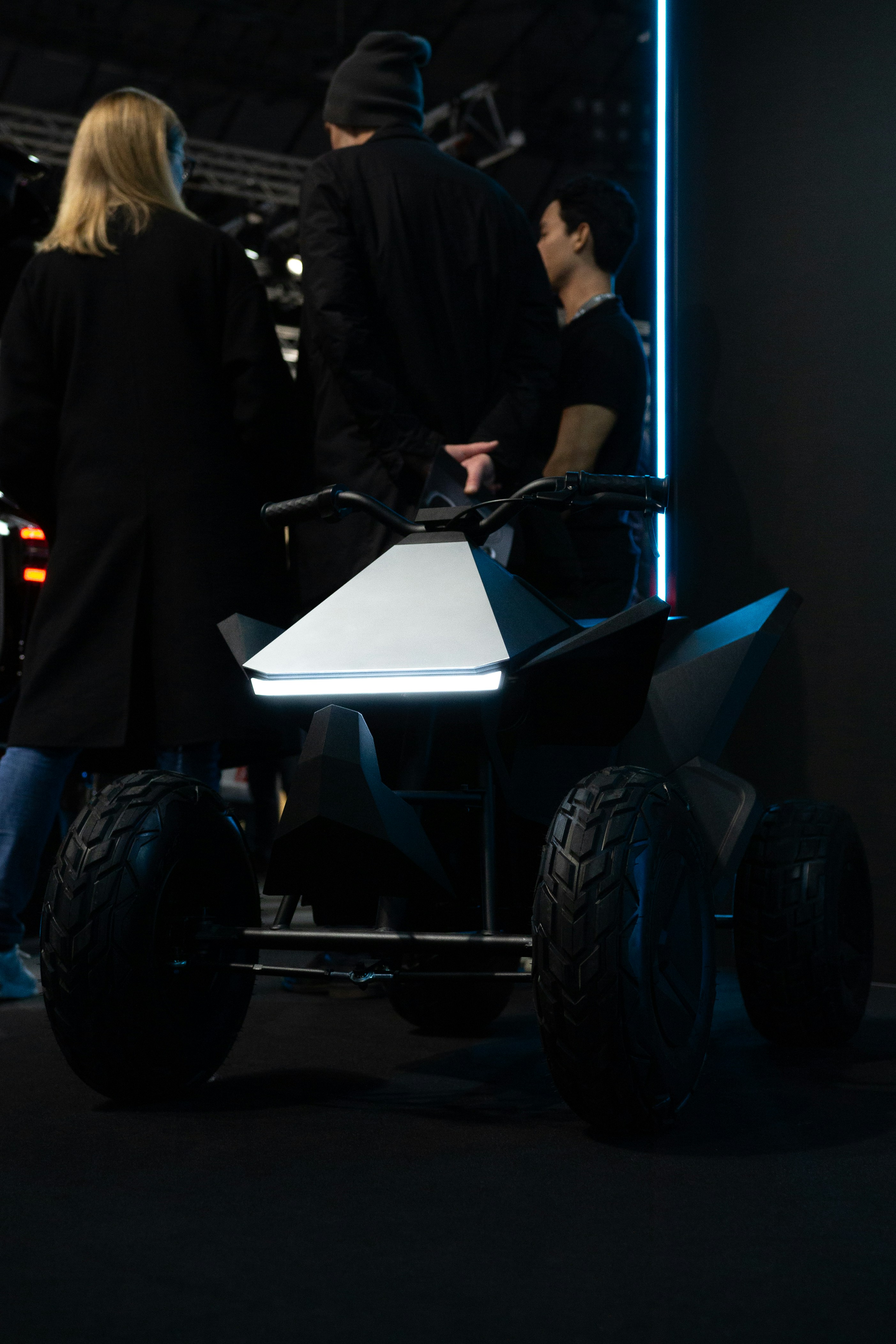 A group of people standing around an atv photo – Free Black Image on ...