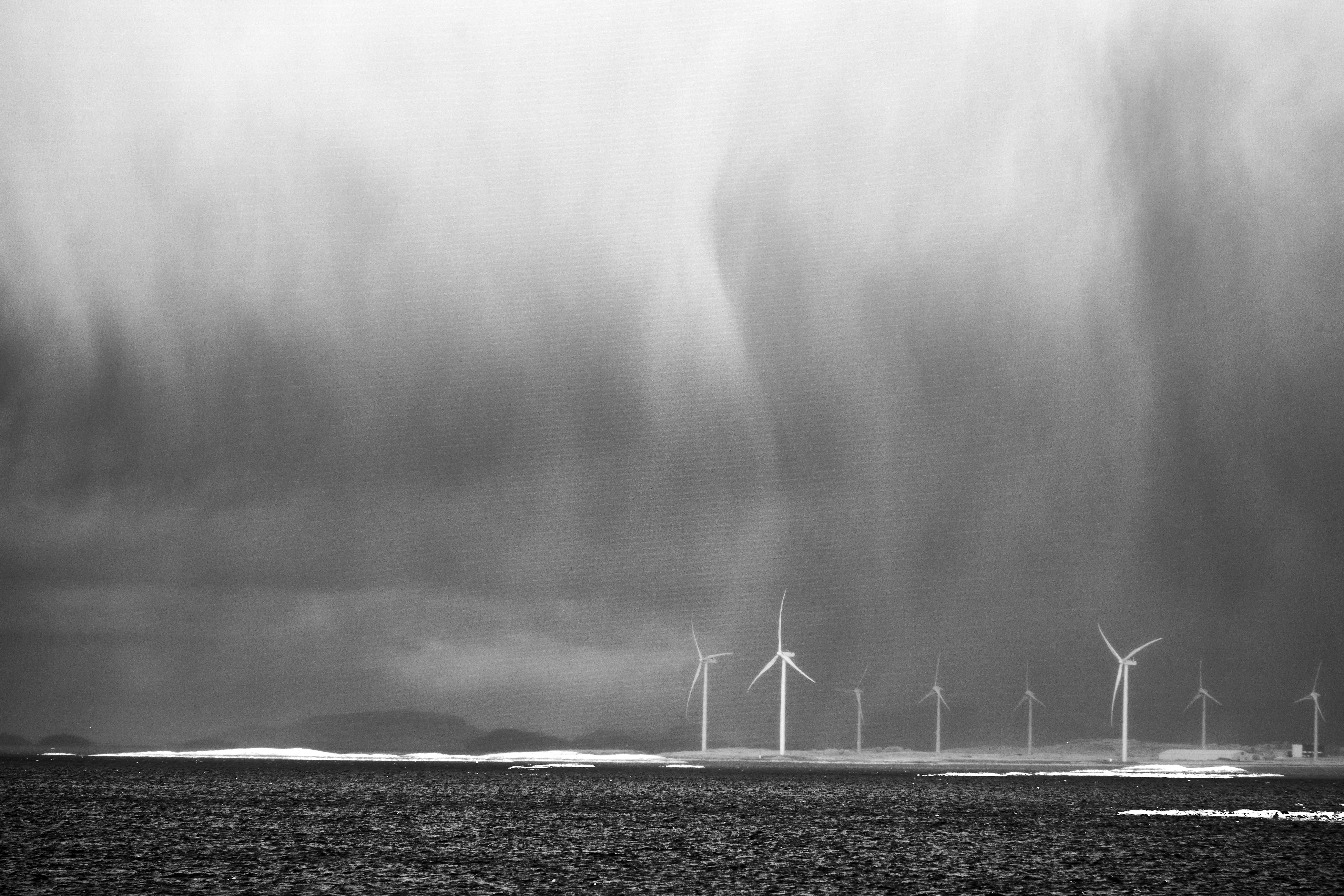 Coastline Sentinels: Wind Turbines Against a Stormy Sky