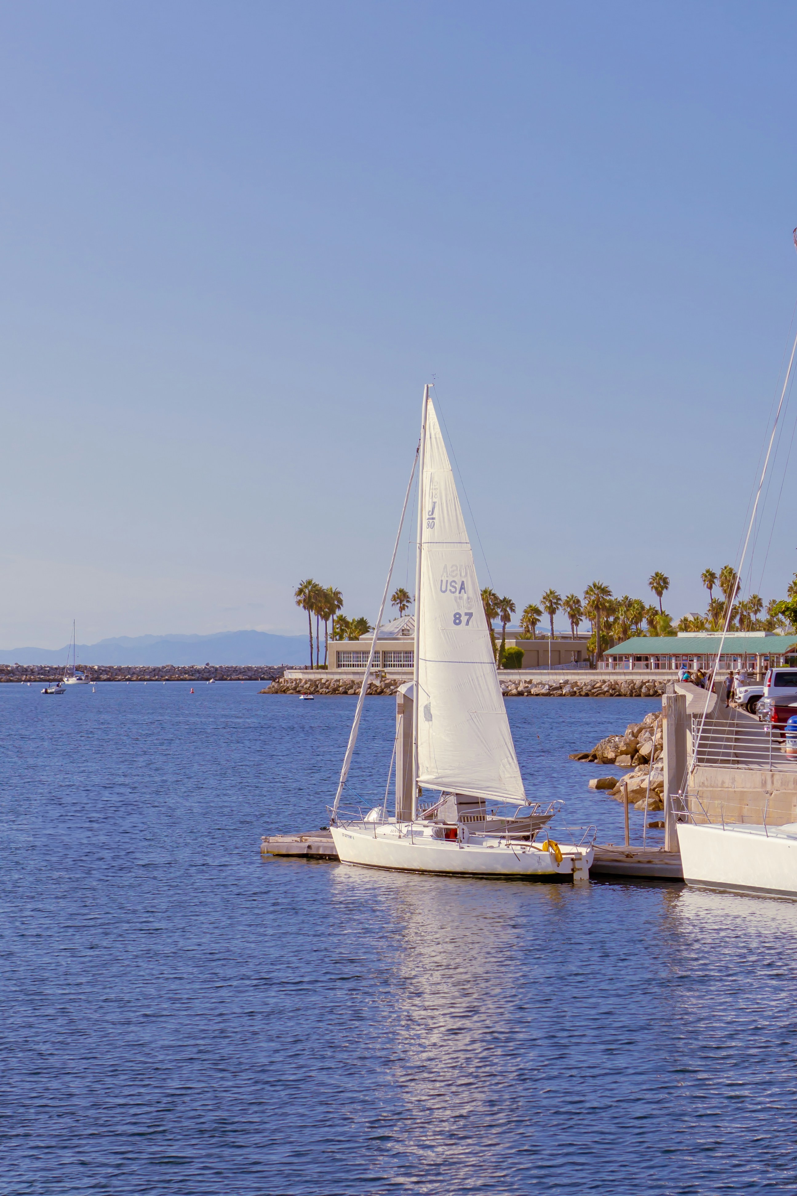 A couple of boats that are in the water photo – Free Beach Image on ...