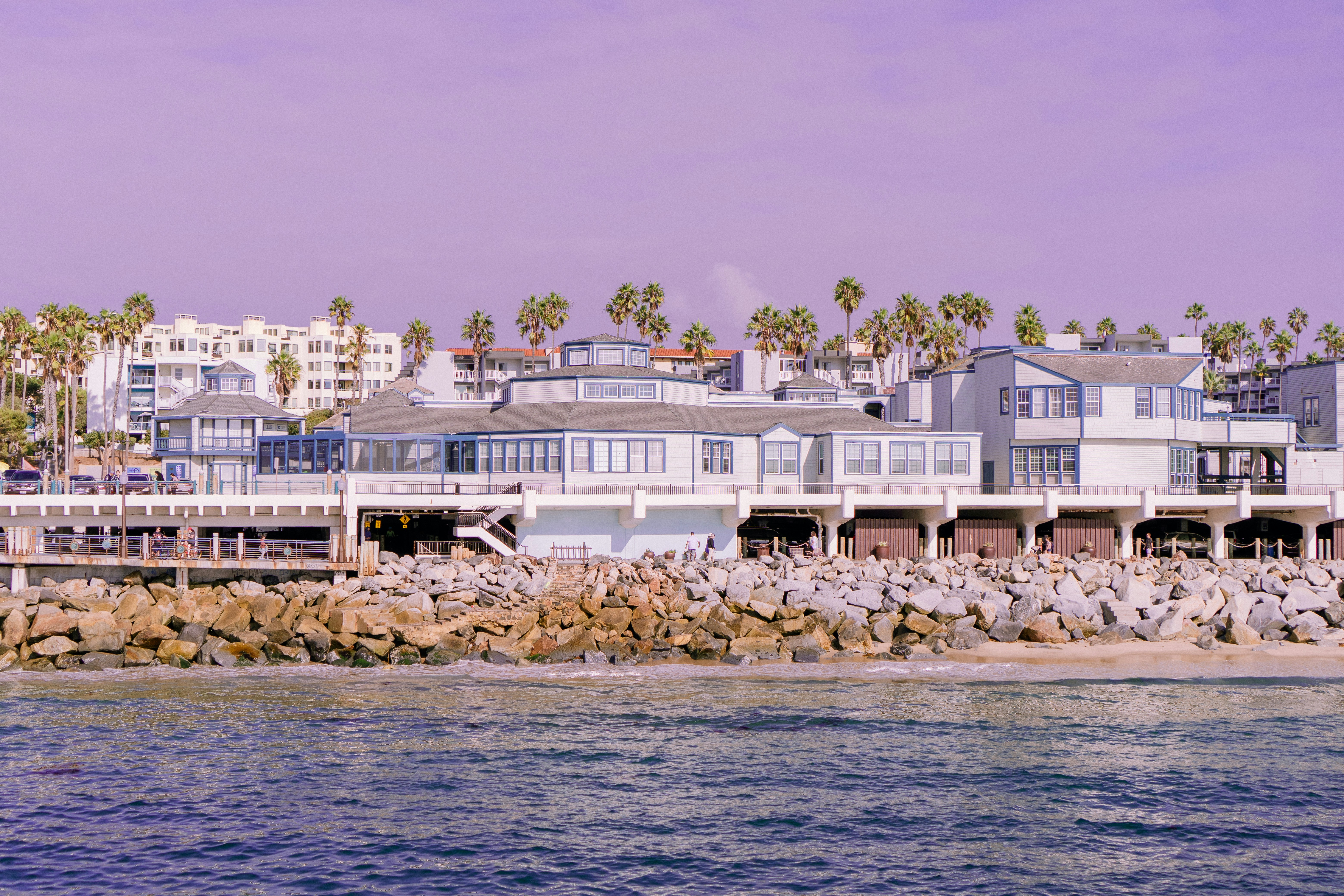 Coastal Boardwalk Homes Beyond a Stony Breakwater
