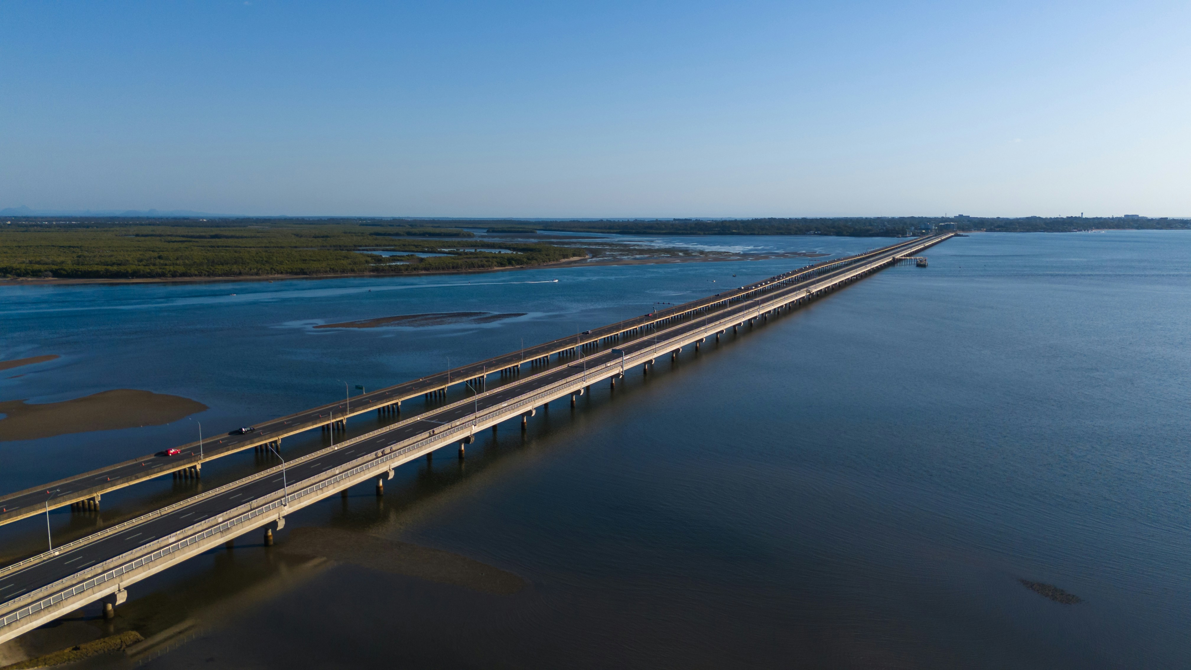 A long bridge over a large body of water photo – Free Wallpaper Image ...