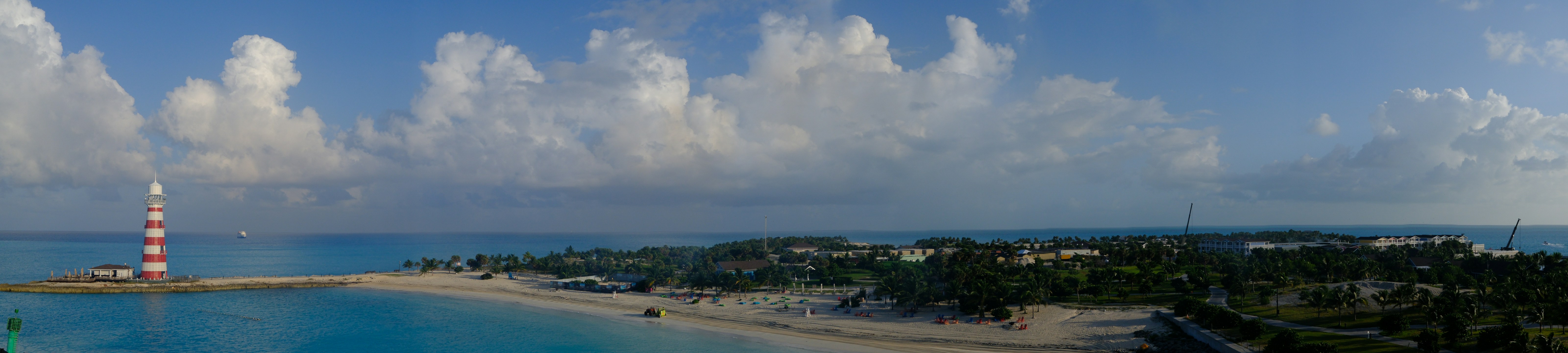 A view of a body of water with a lighthouse in the distance photo ...