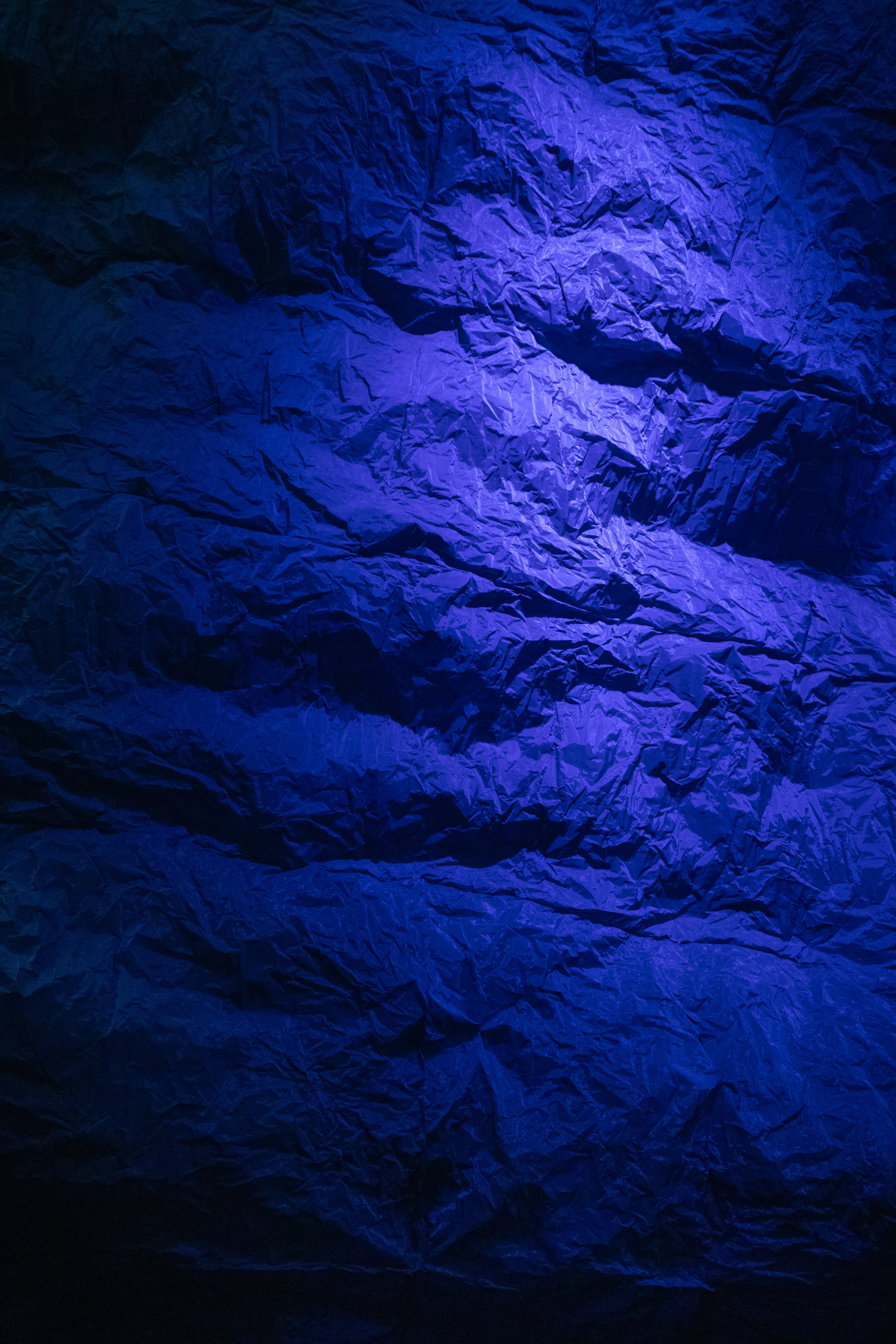 A dark room with a blue light in the middle of itFilipe Nobre