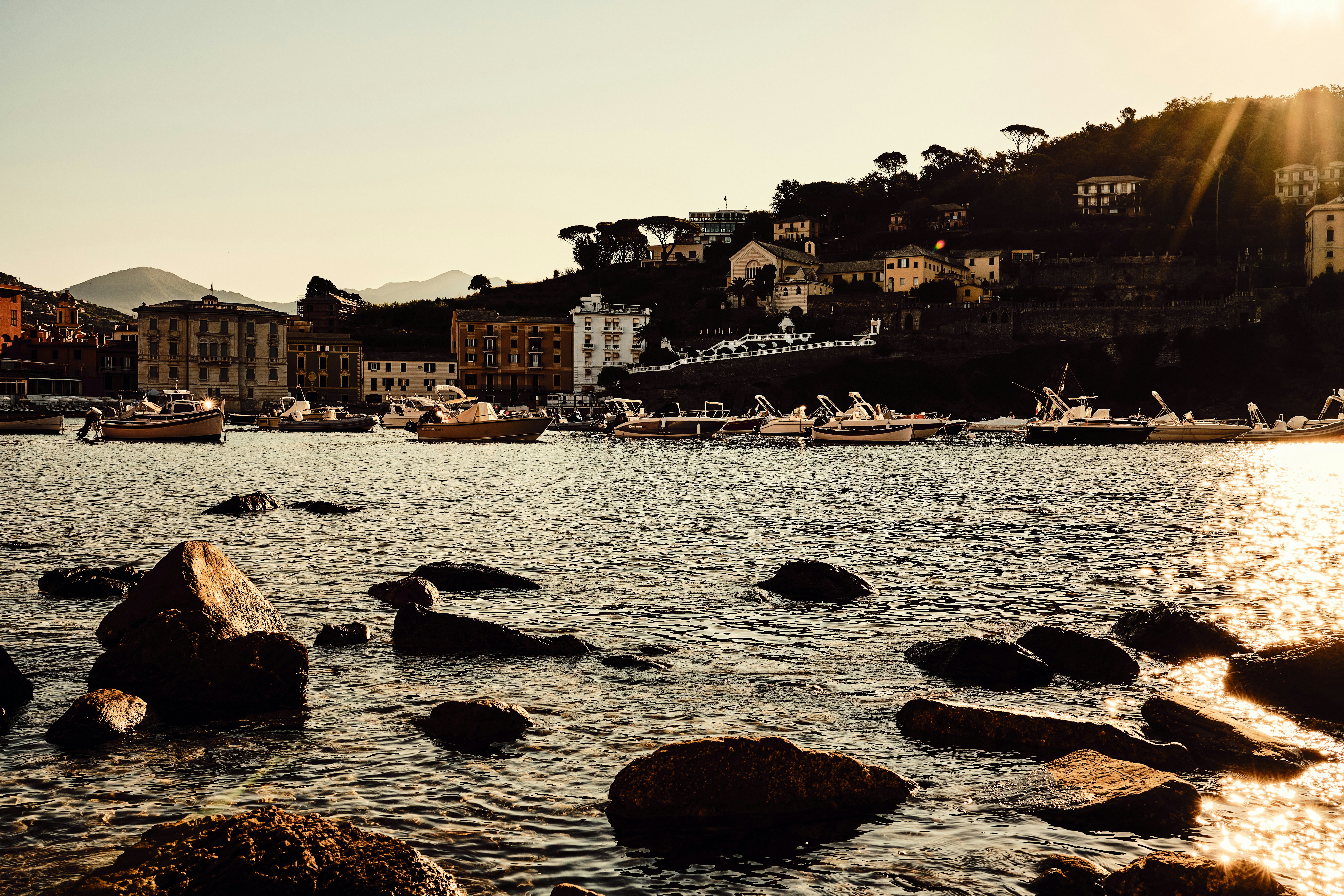 A body of water surrounded by rocks and buildings photo – Free Sestri ...
