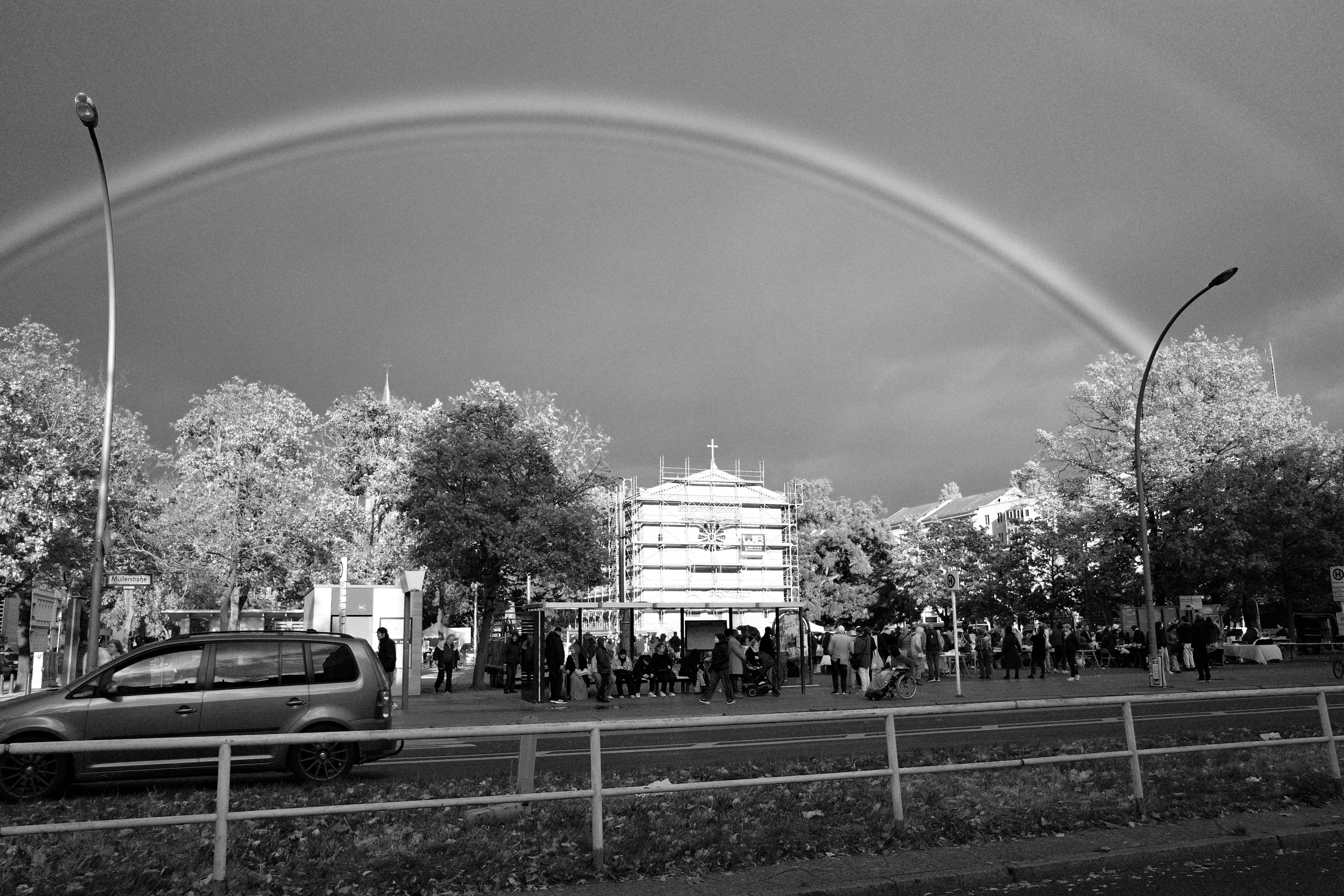 Rainbow Halo Over the Civic Square: A Monochrome Street Scene