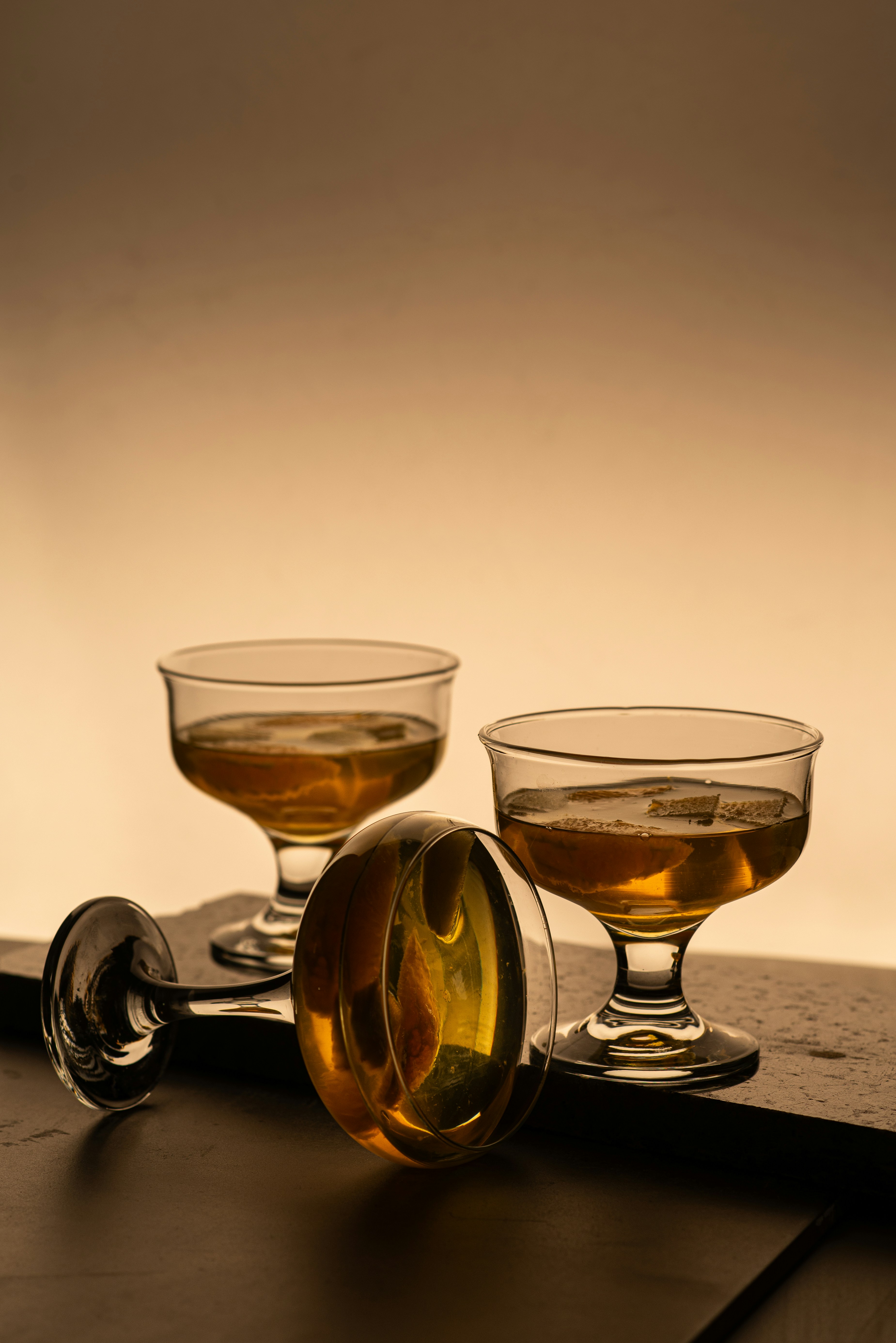 Amber Echoes on a Dim Table: Glassware in Warm Light