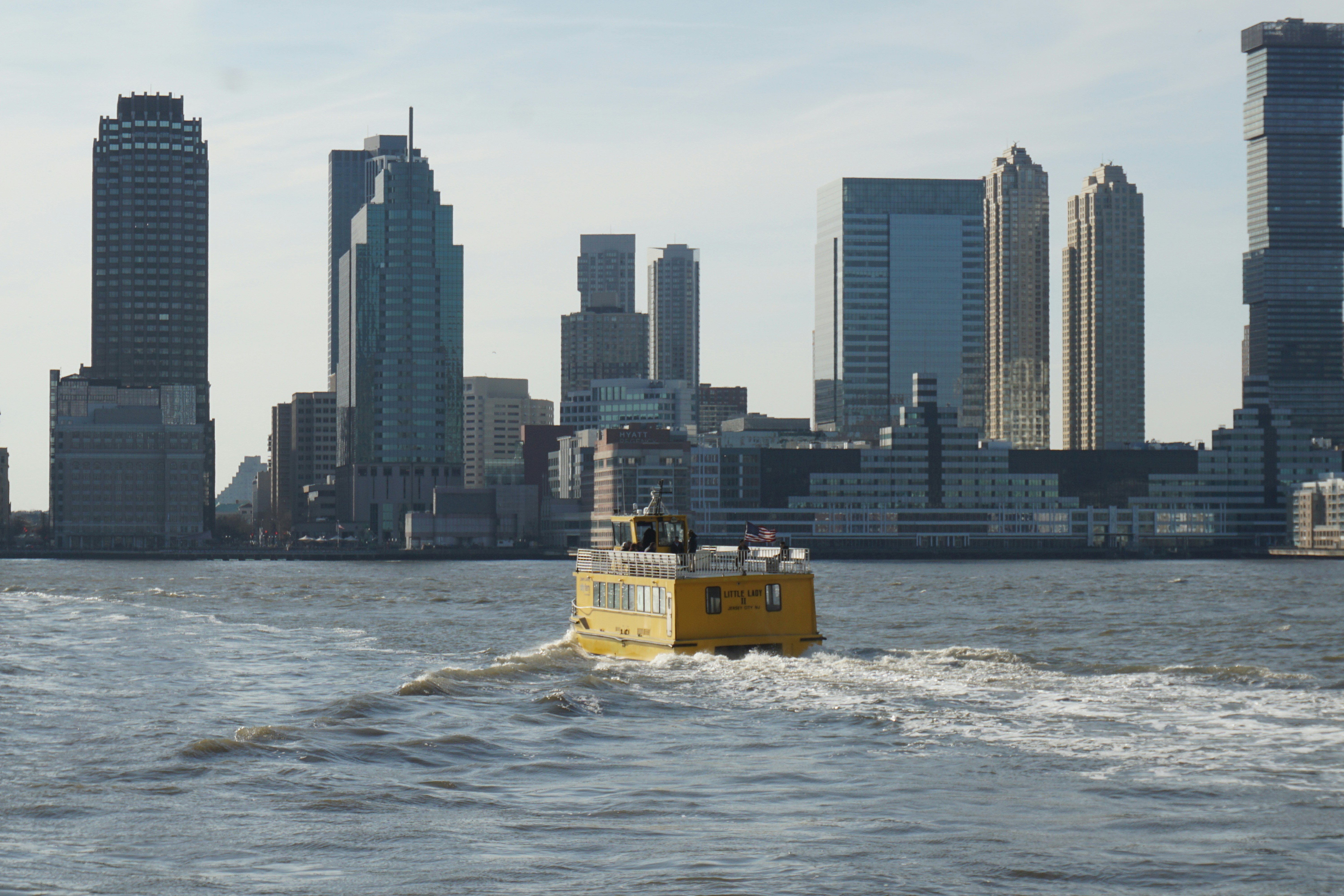 Cityscape Ferry Slicing Through a Glassy Harbor