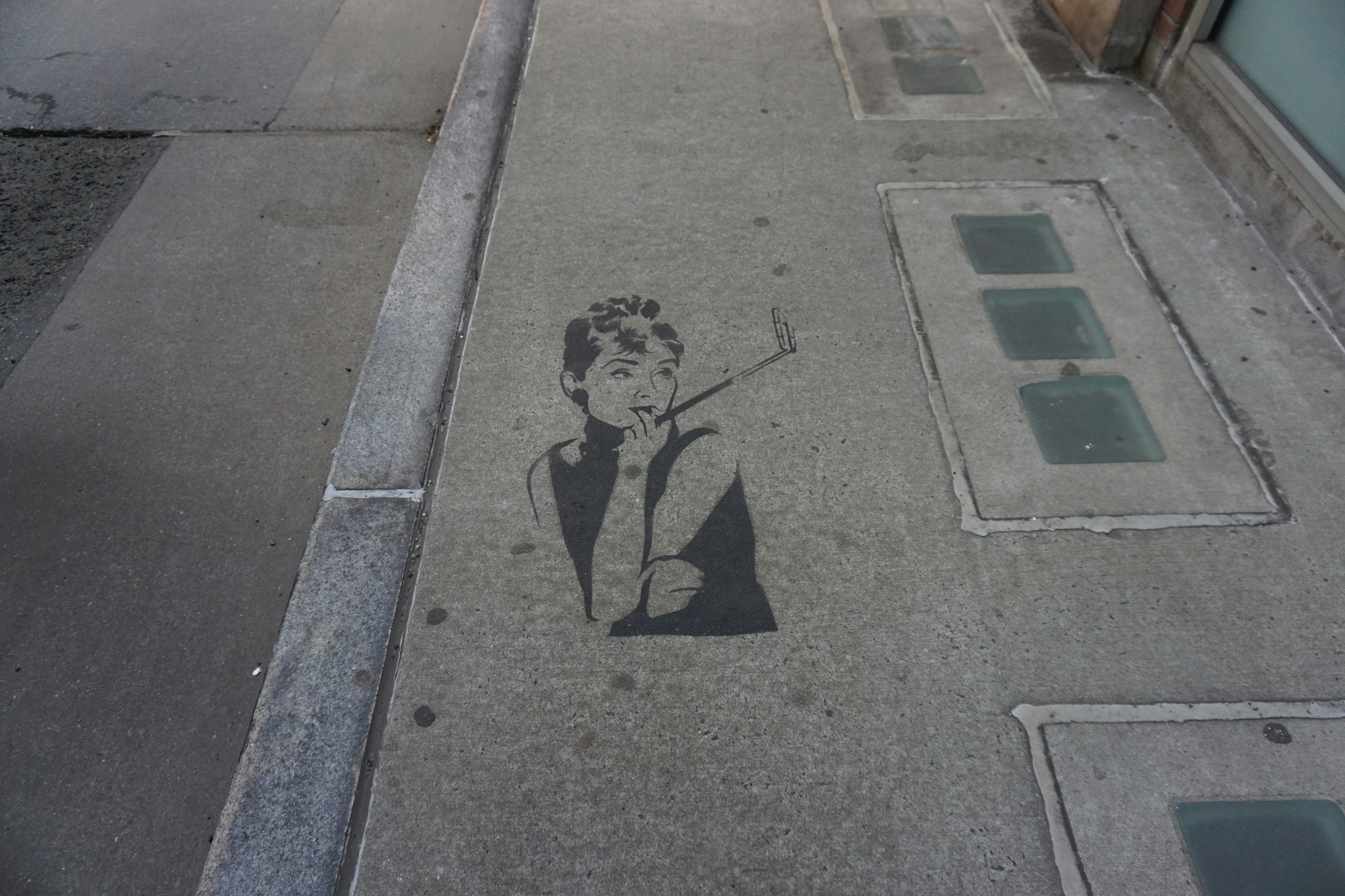 Audrey Hepburn Stencil Grace on a Quiet City Sidewalk