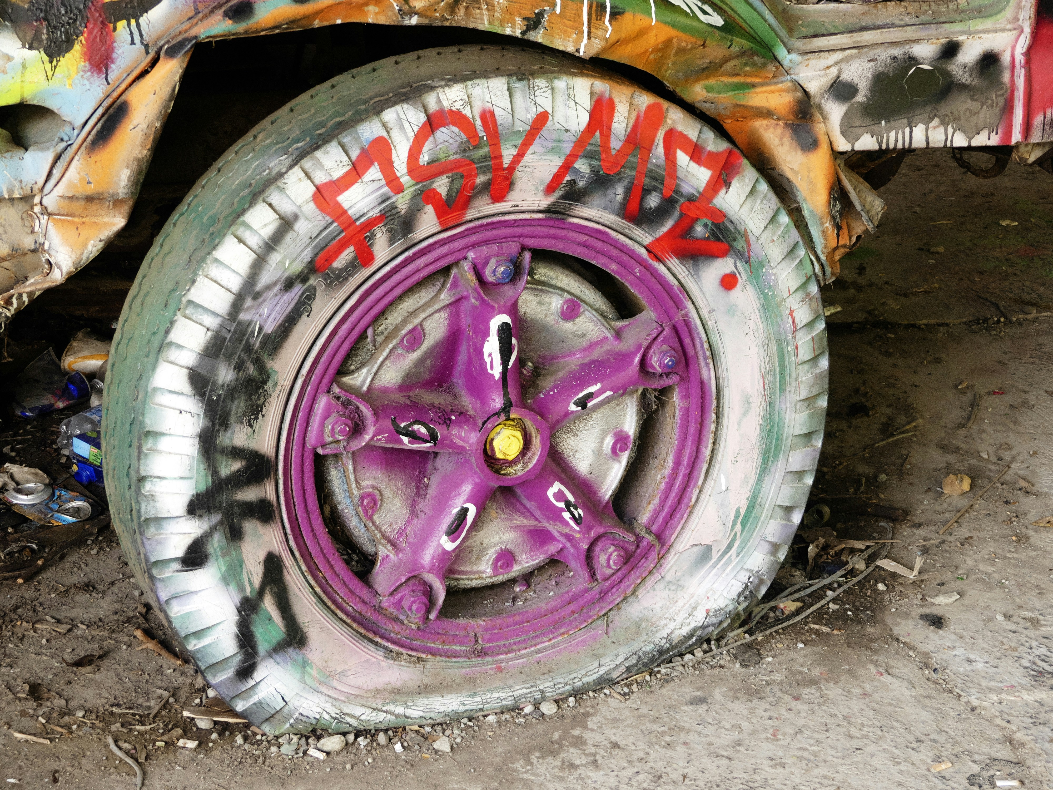 Violet Spokes Under a Spray-Painted Street Scene