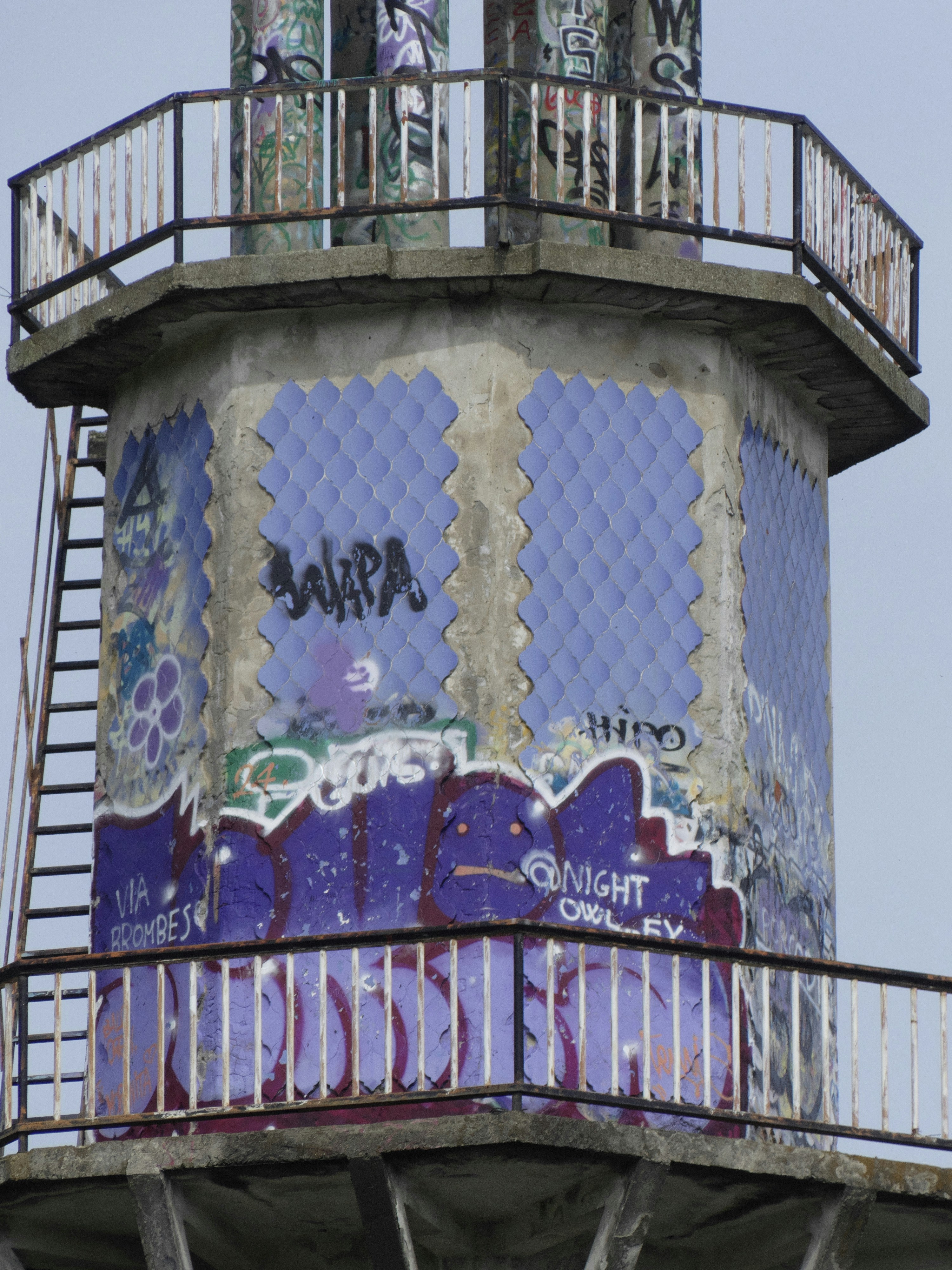 Azure Diamond Facade: A Graffiti-Clad Lookout Tower