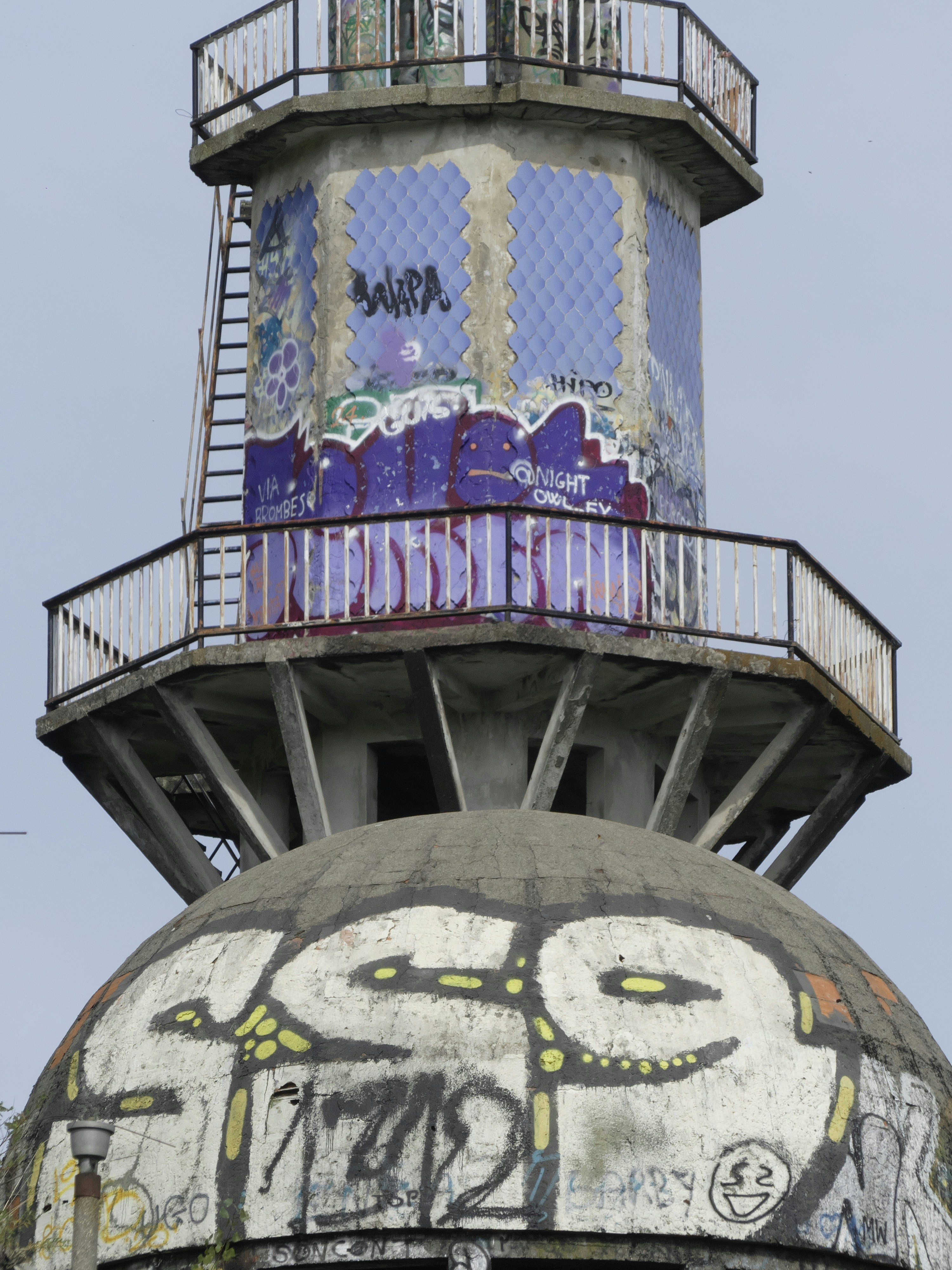 A tall tower with graffiti on the side of it photo – Free Monastery ...