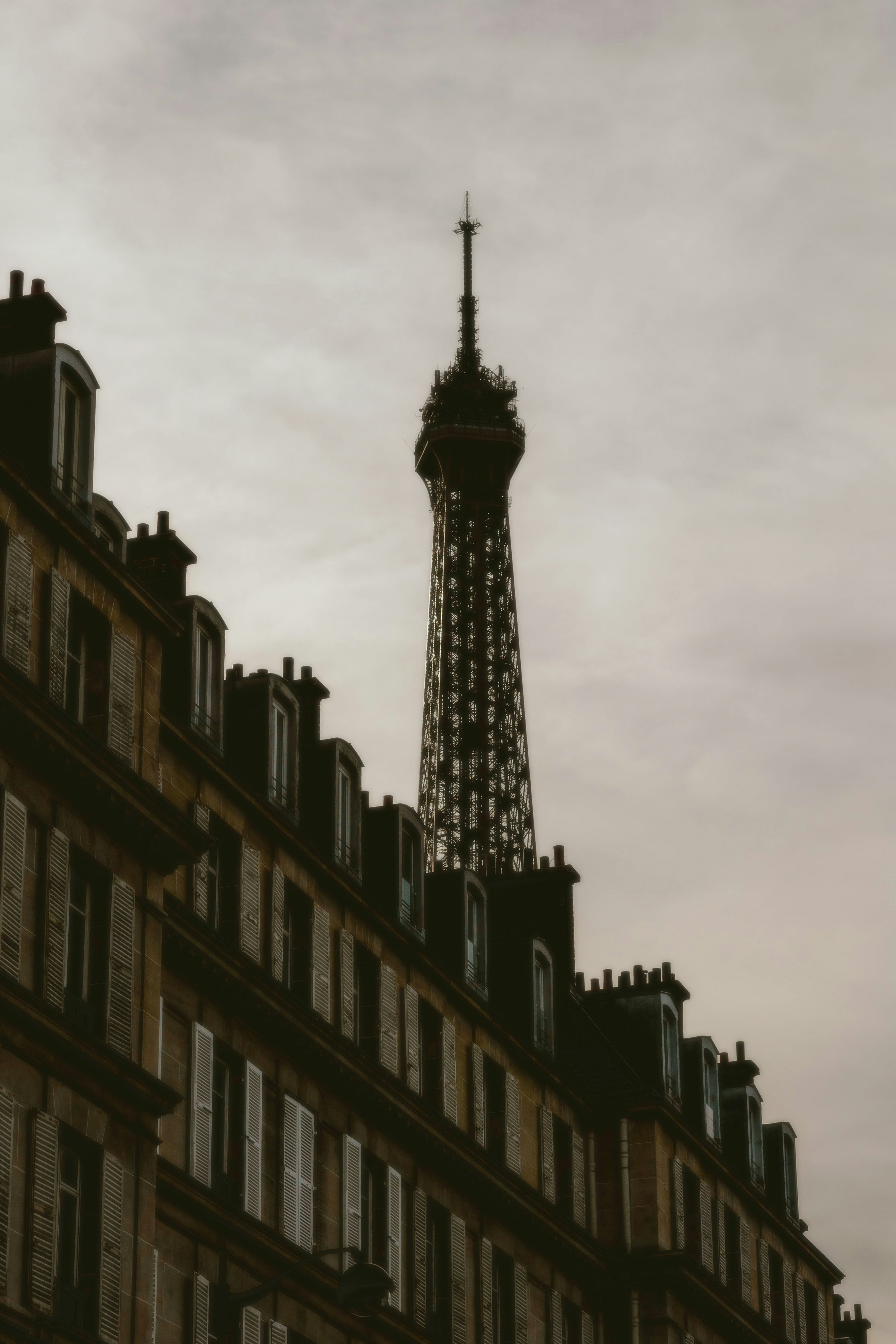 Eiffel on the Horizon: Sepia Parisian Rooftops Under a Muted Sky