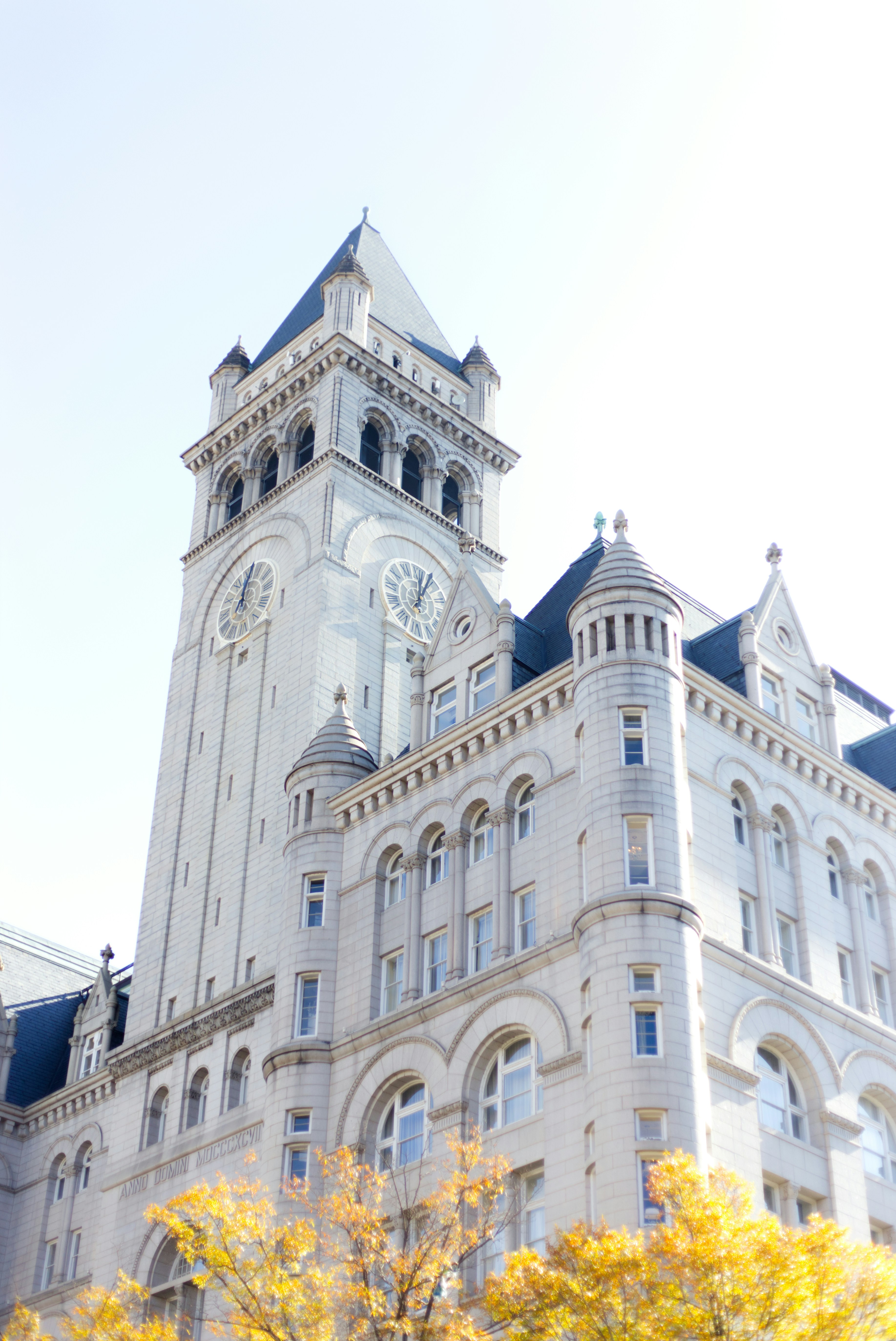 A large white building with a clock tower photo – Free Hotel Image on ...