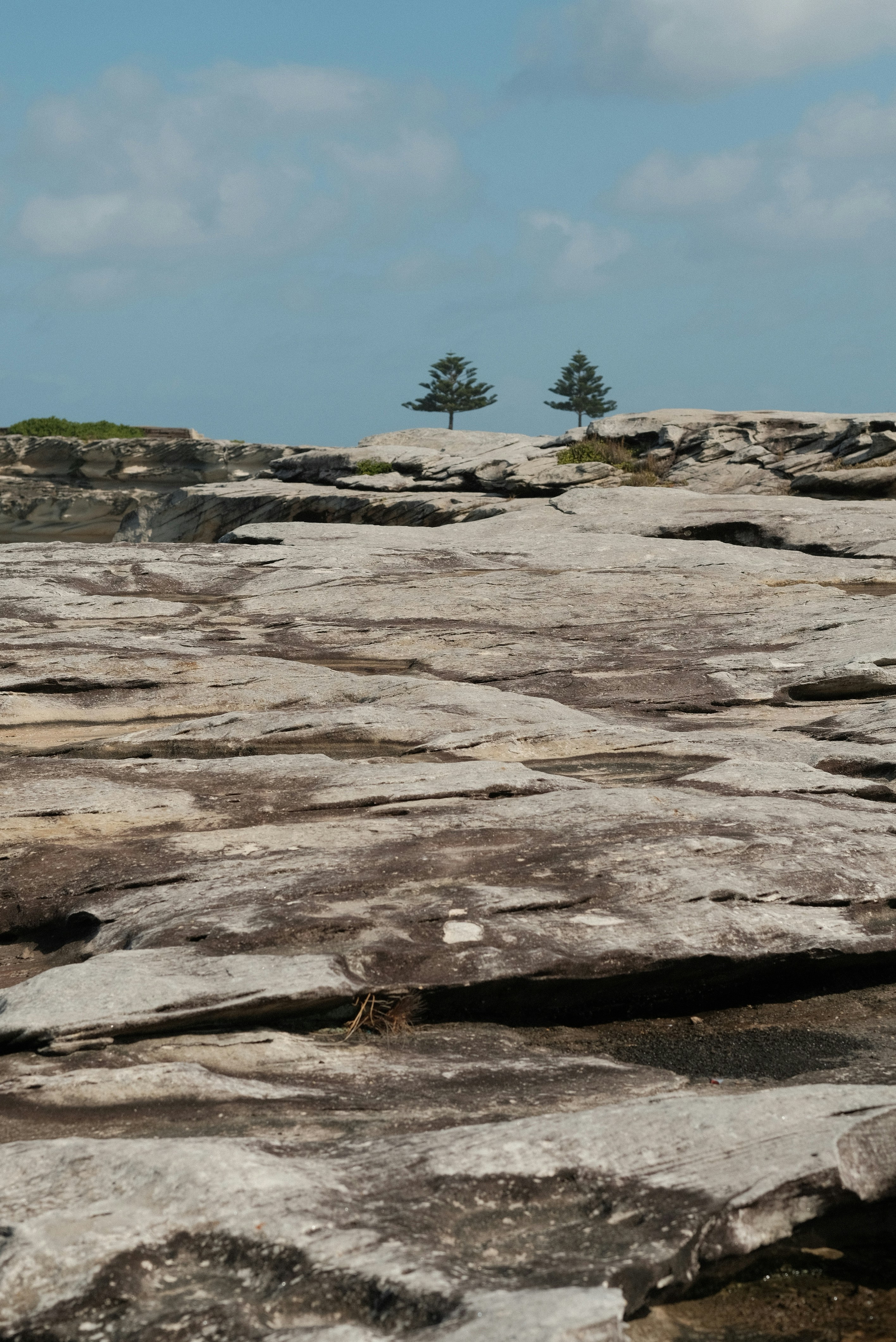 A man standing on top of a large rock formation