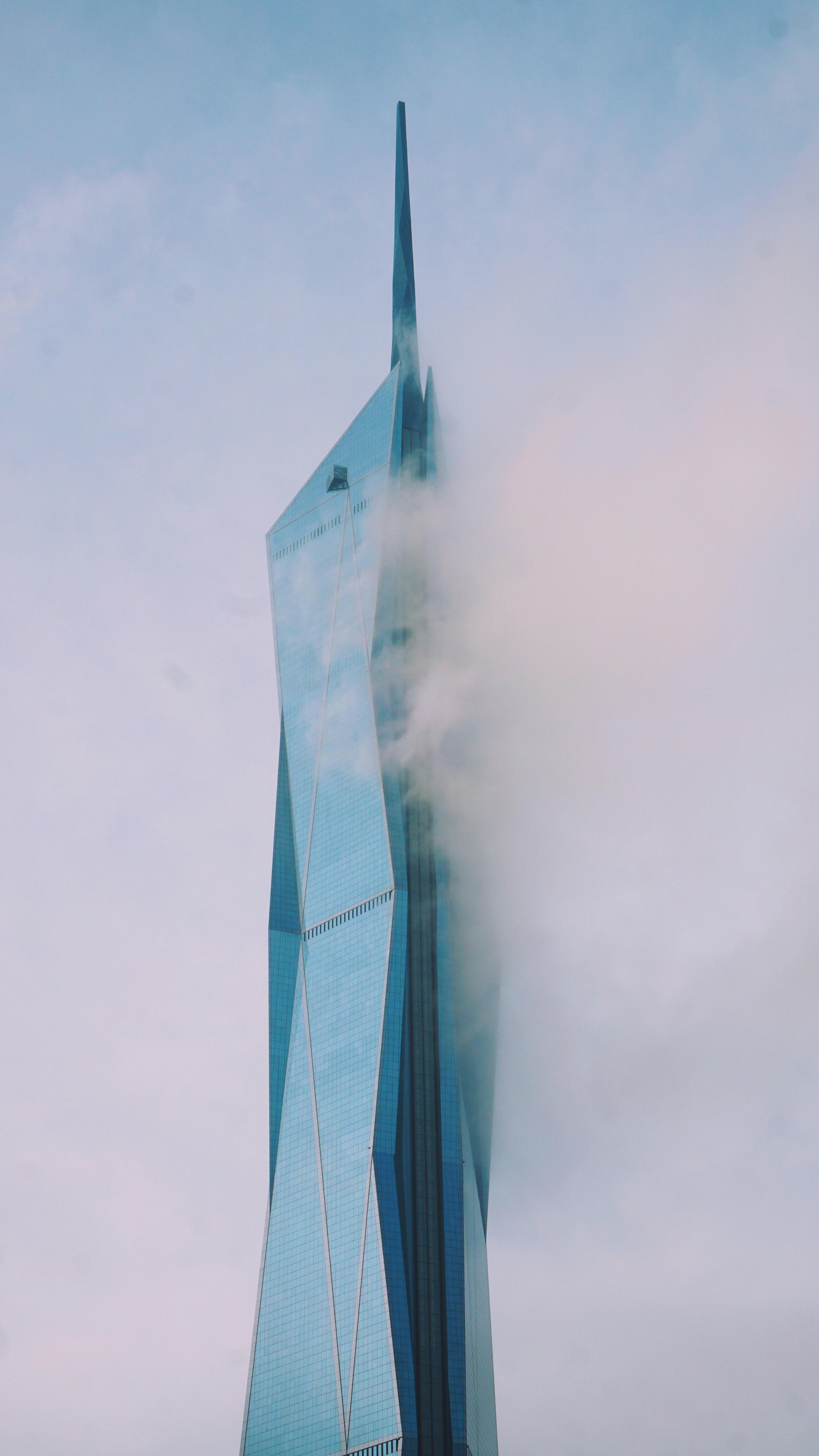 A tall building with a very tall spire sticking out of it's side photo ...