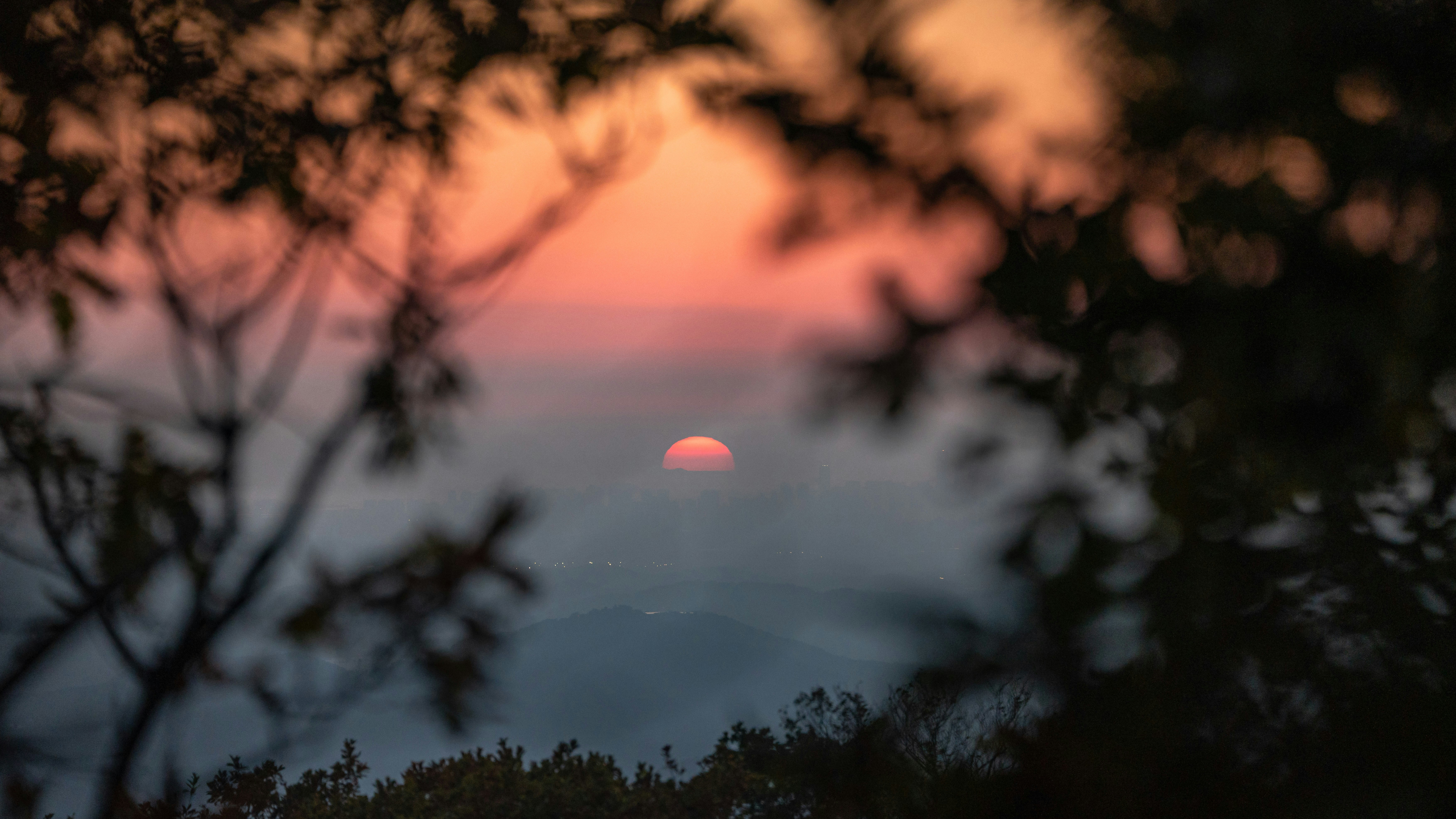 Red Ember Over a Misty Ridge at Dusk